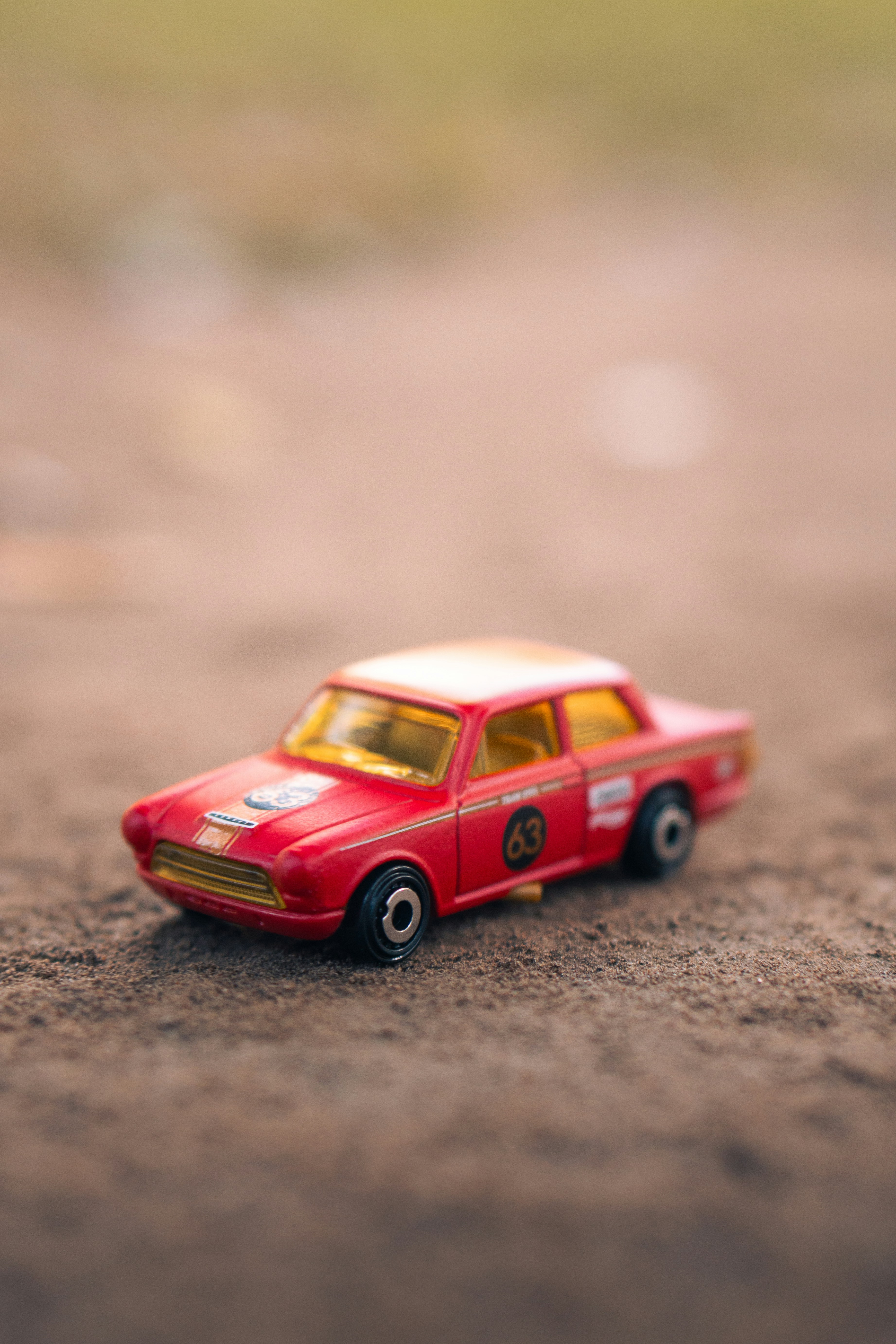 Tiny Red Racer on a Dirt Track