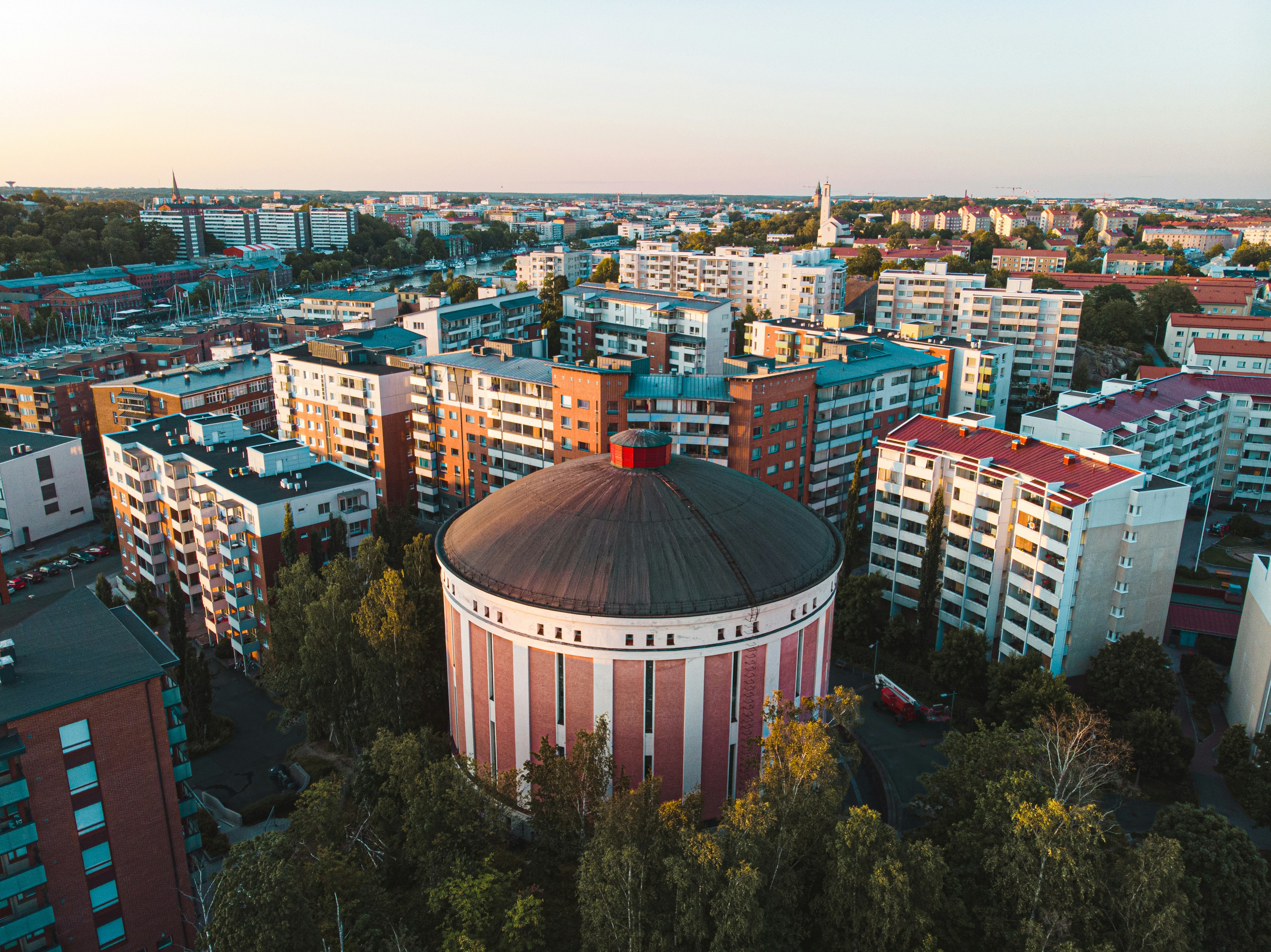 Circular Rooftop Collector Surrounded by pastel Urban Blocks