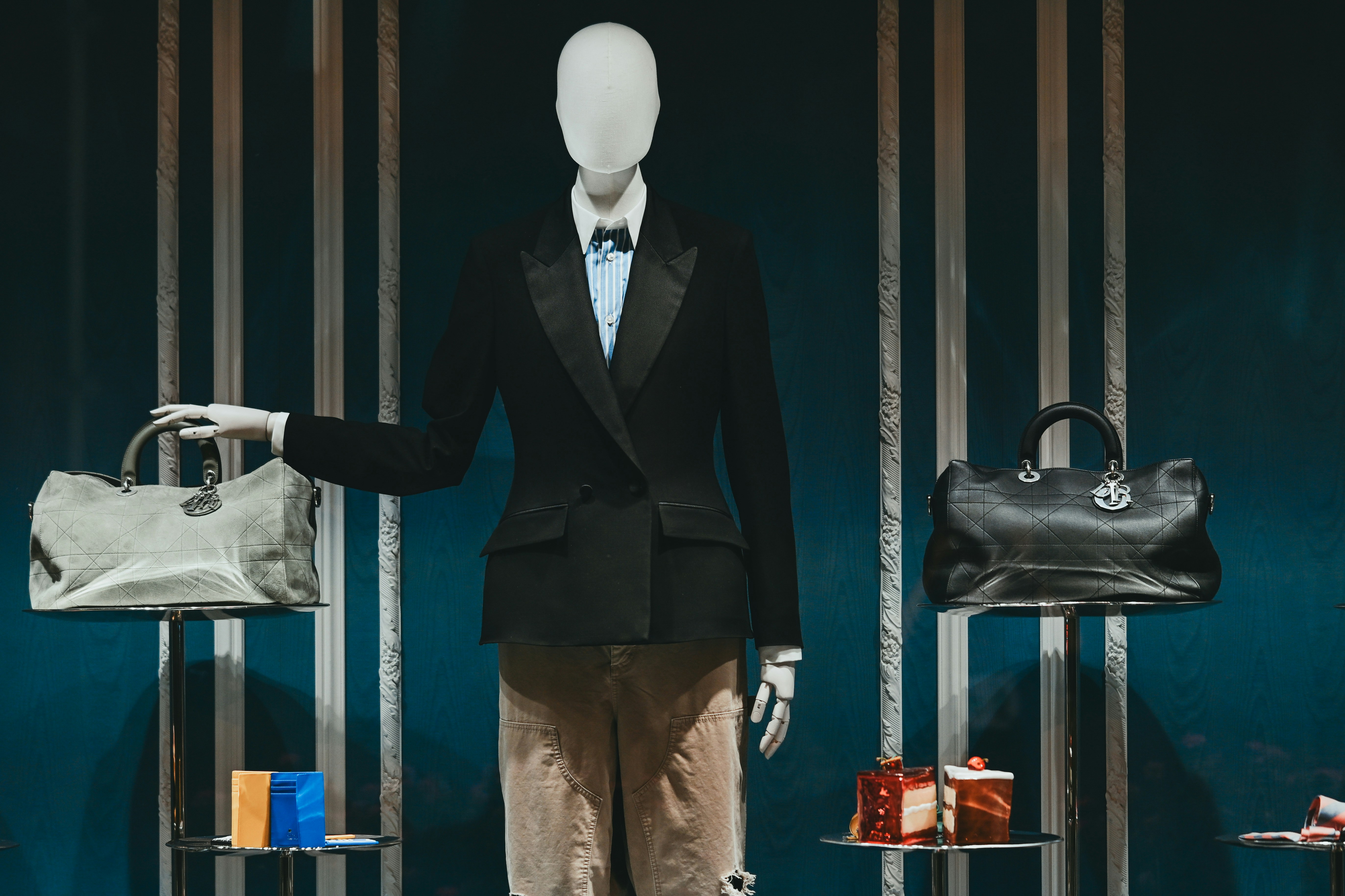 Boutique Window: A Tailored Mannequin amid Shimmering Bags