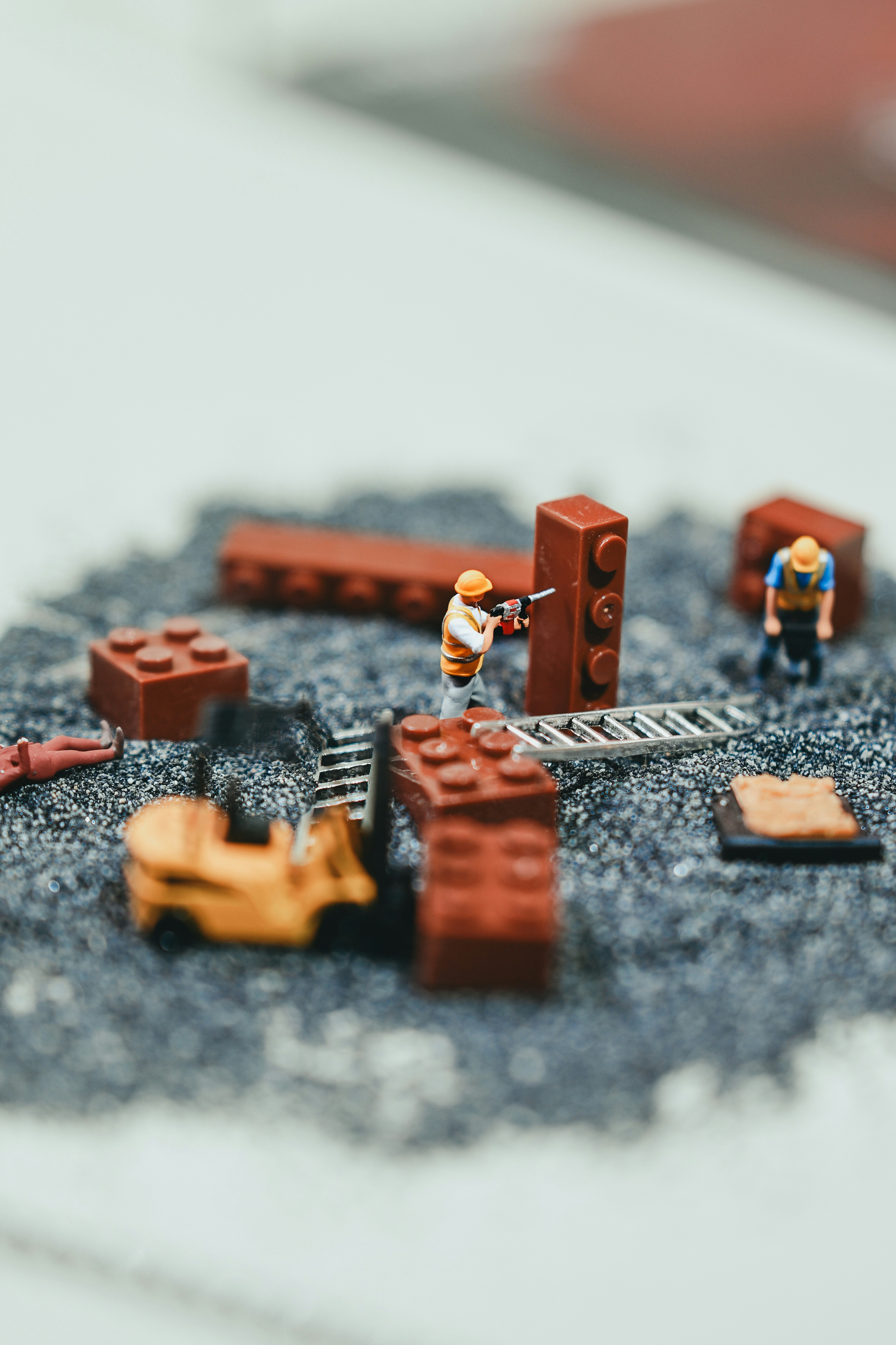 Miniature Construction Crew at Ground-Level Break Ground