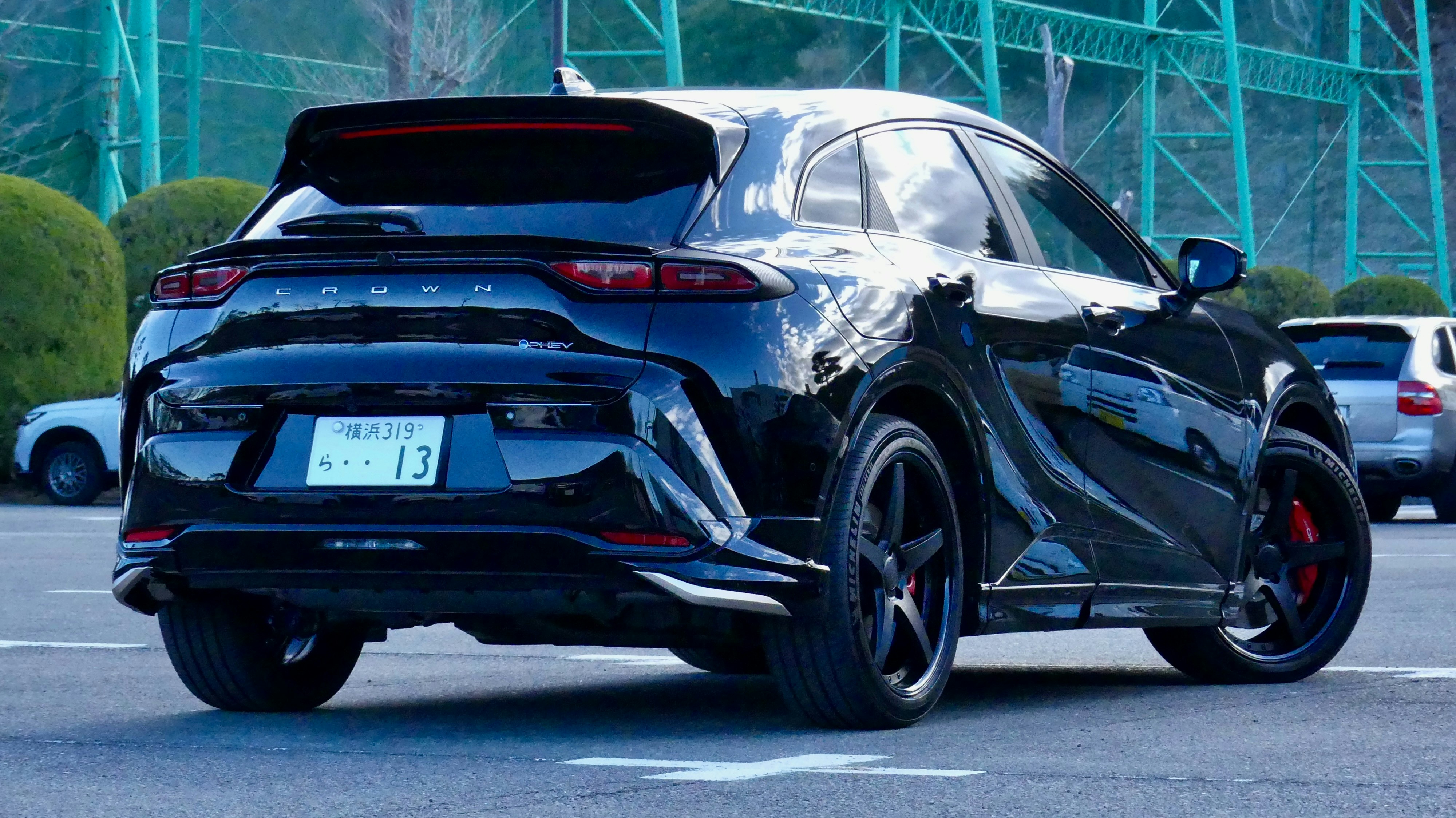 Night-Shift Sleek: Black Porsche SUV in a Parking Lot