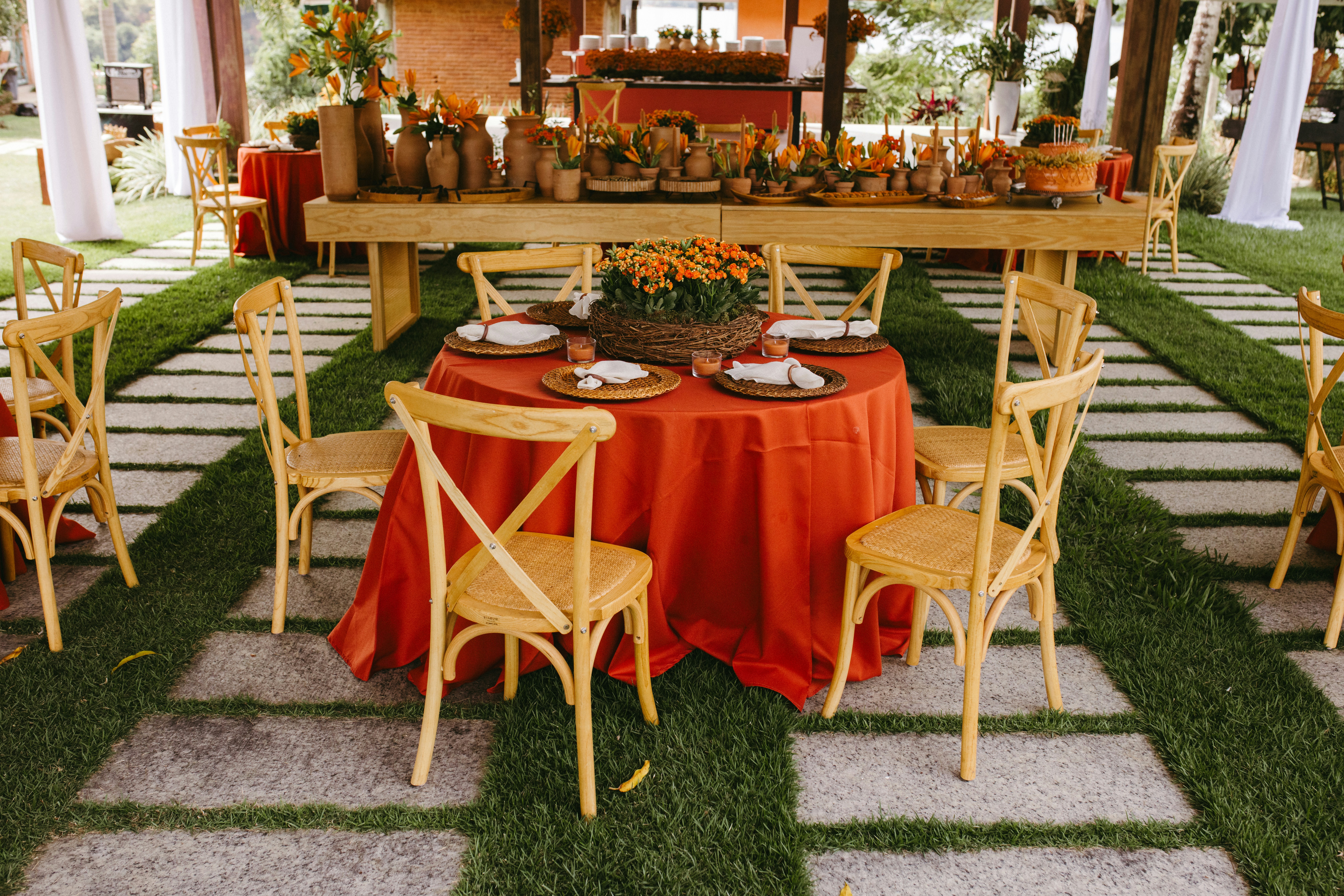 Orange Centerpiece Under a Patio Tent: Rustic Reception Table Set for an Outdoor Wedding