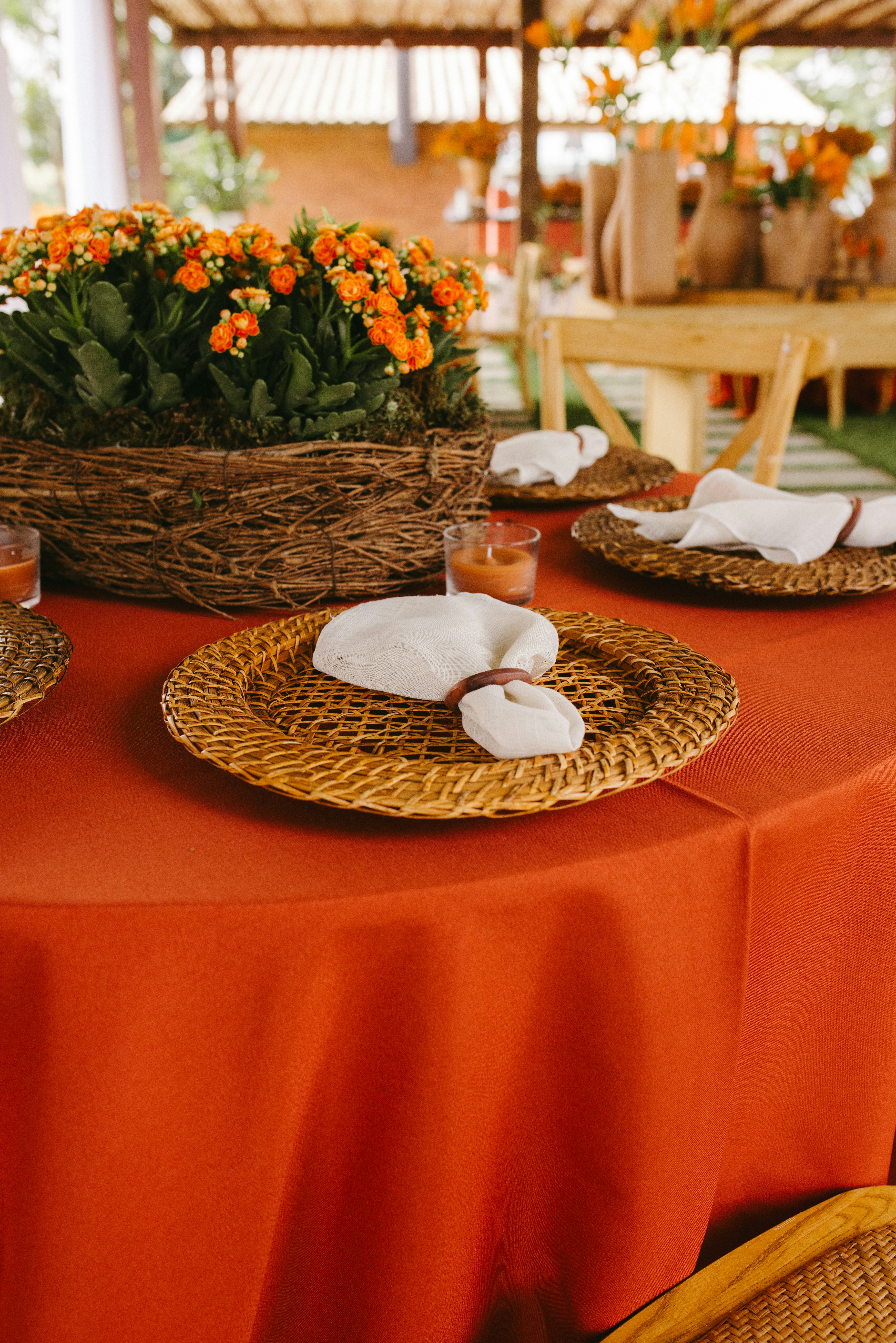 Ivory napkins on a sunlit autumn table centerpiece of orange blossoms