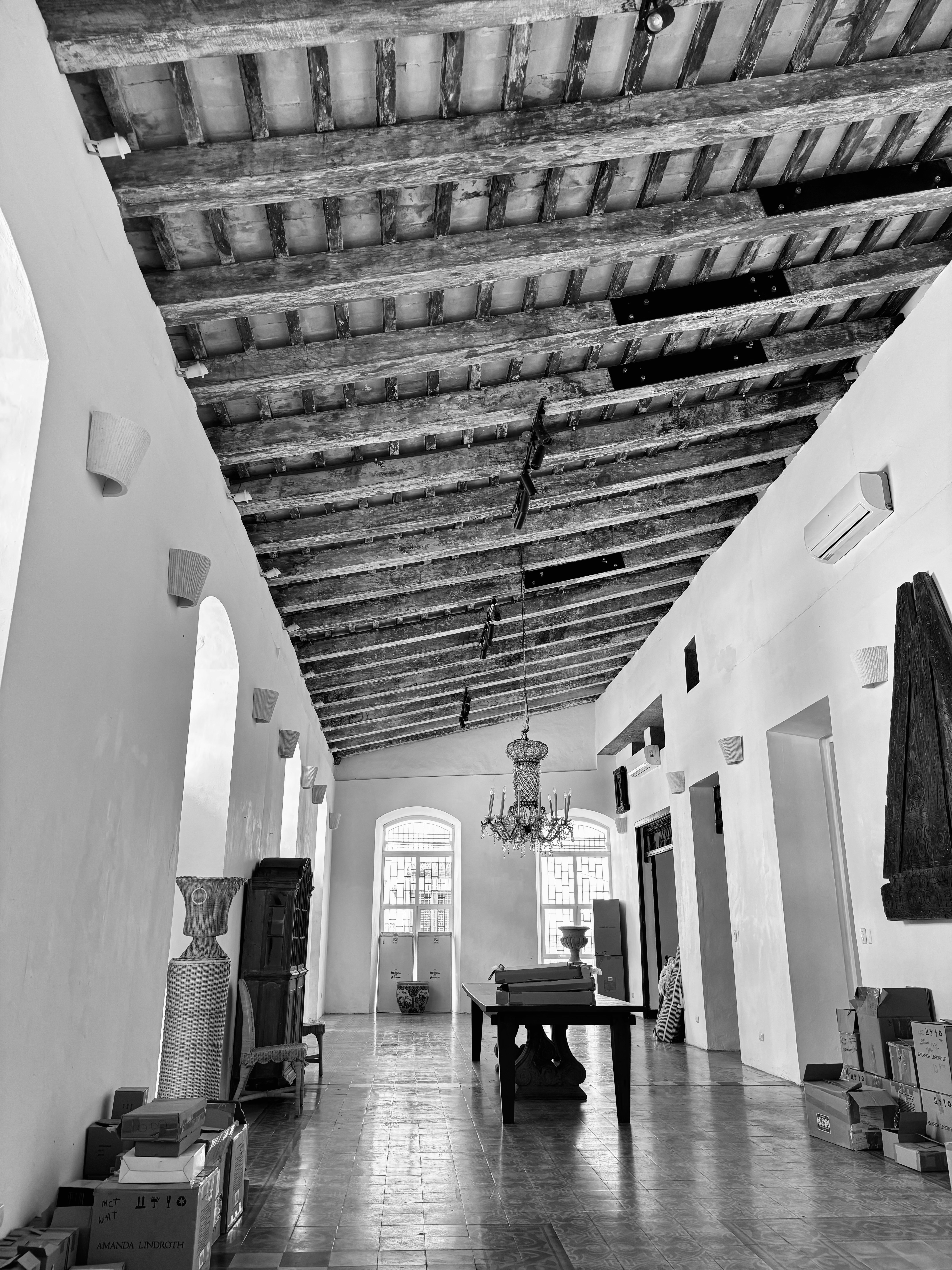 Sunken Ceiling, Open Heritage: A Monochrome Hall with Timeworn Roof Beams