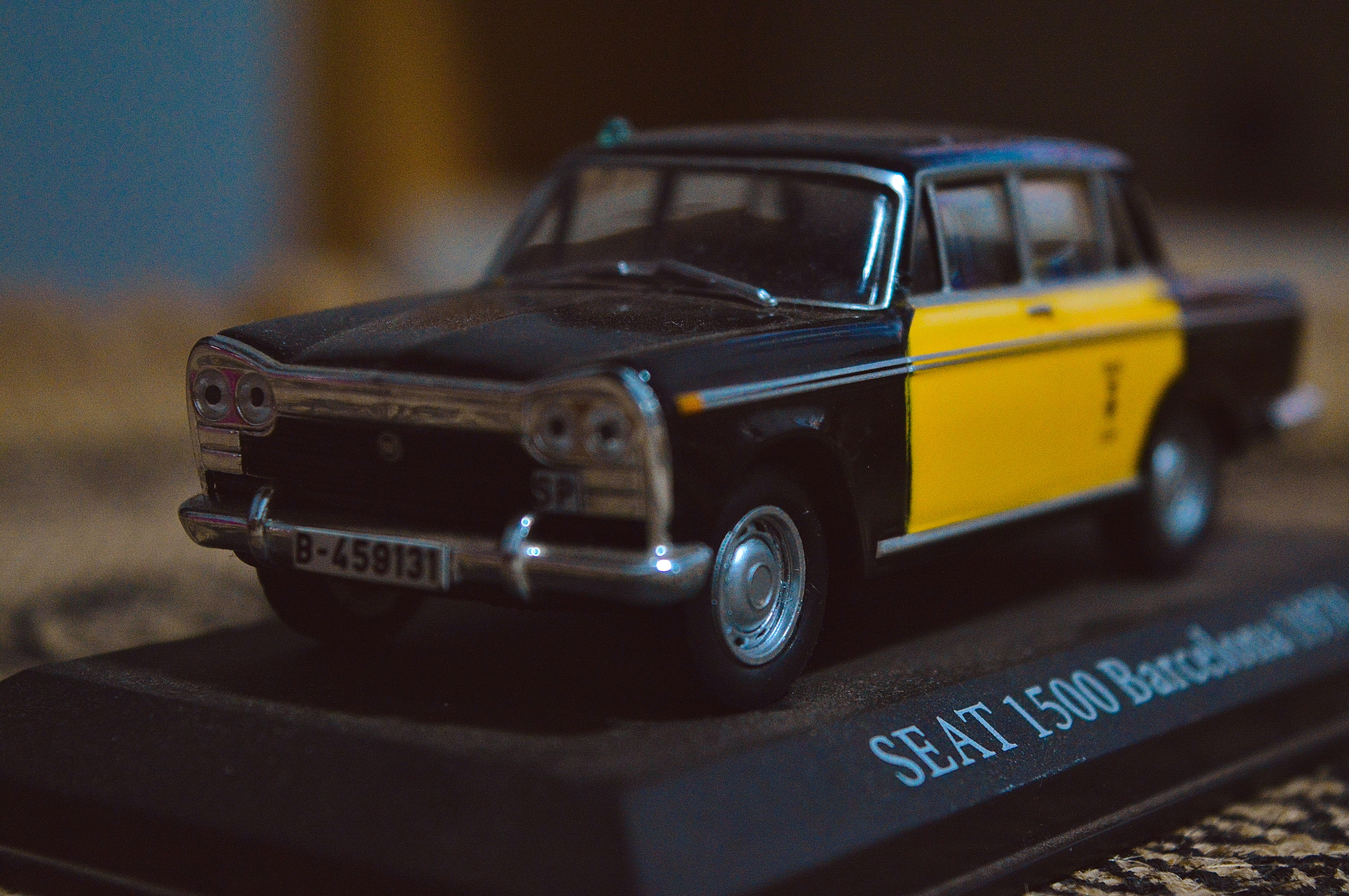 Miniature Corp: A Classic Police Sedan on a Dark Desk Stage