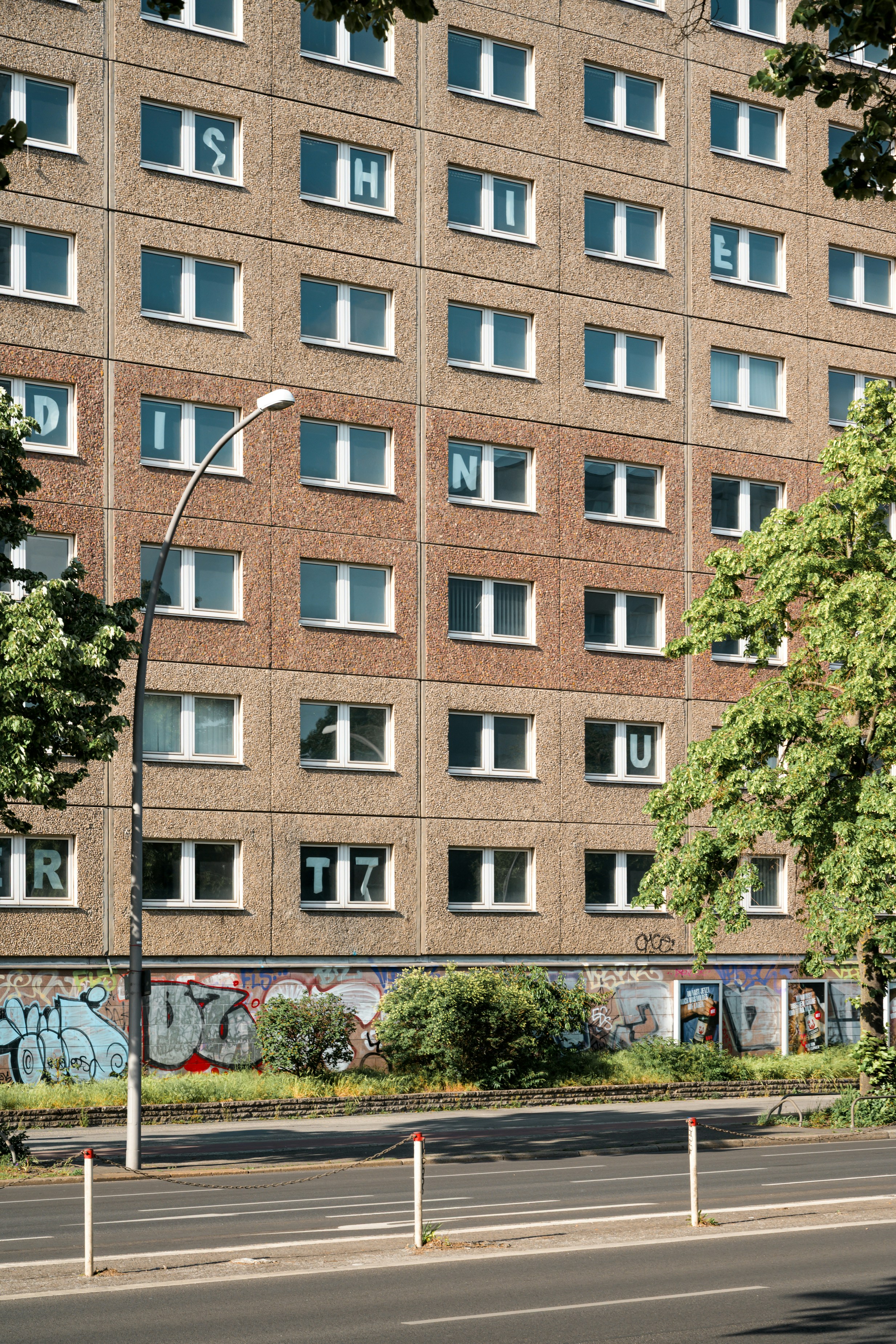 Concrete Facade with Alphabetic Windows and Graffiti Chorus