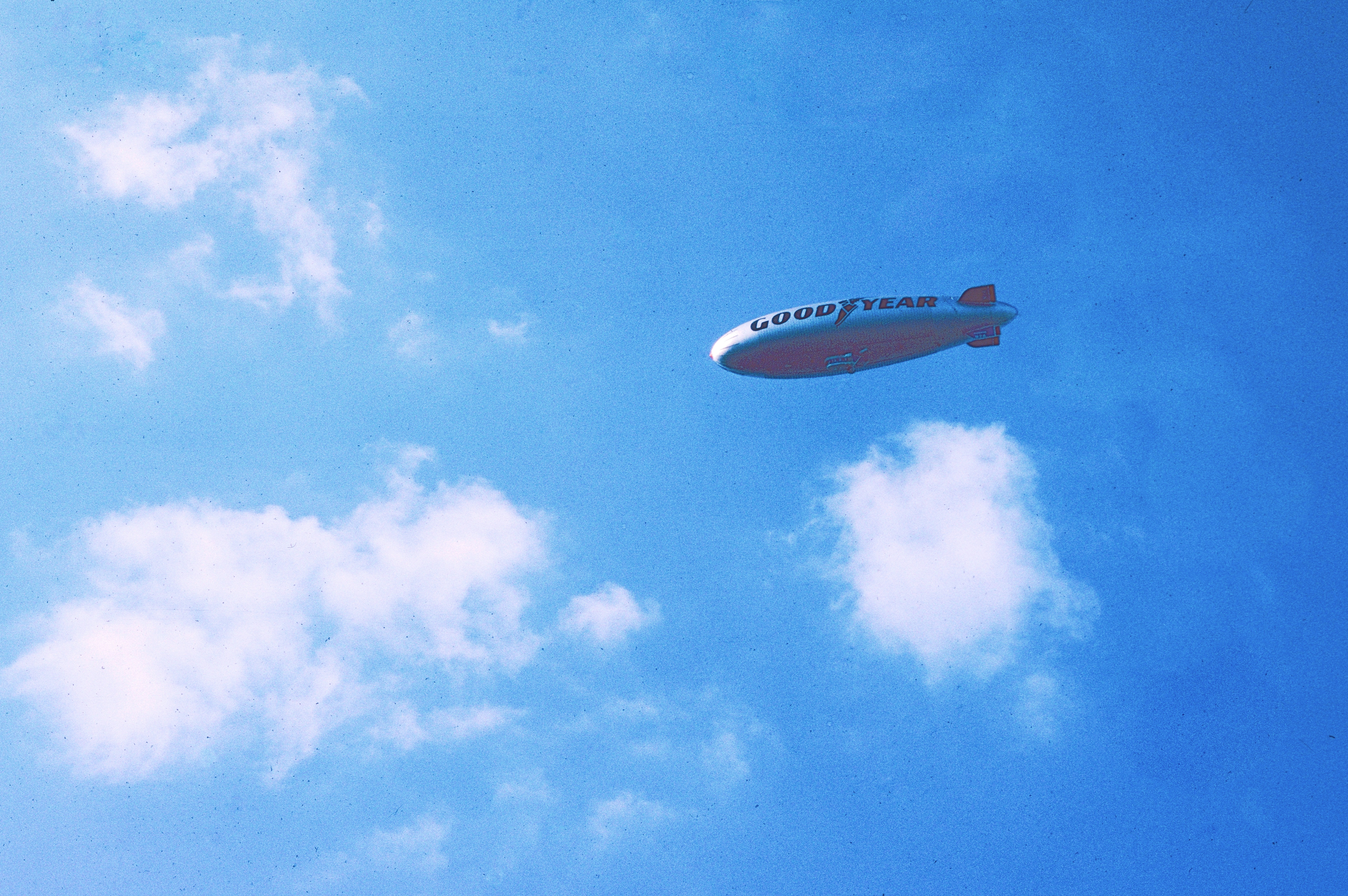 Go Fly: A Goodyear blimp drifts through a bright blue sky