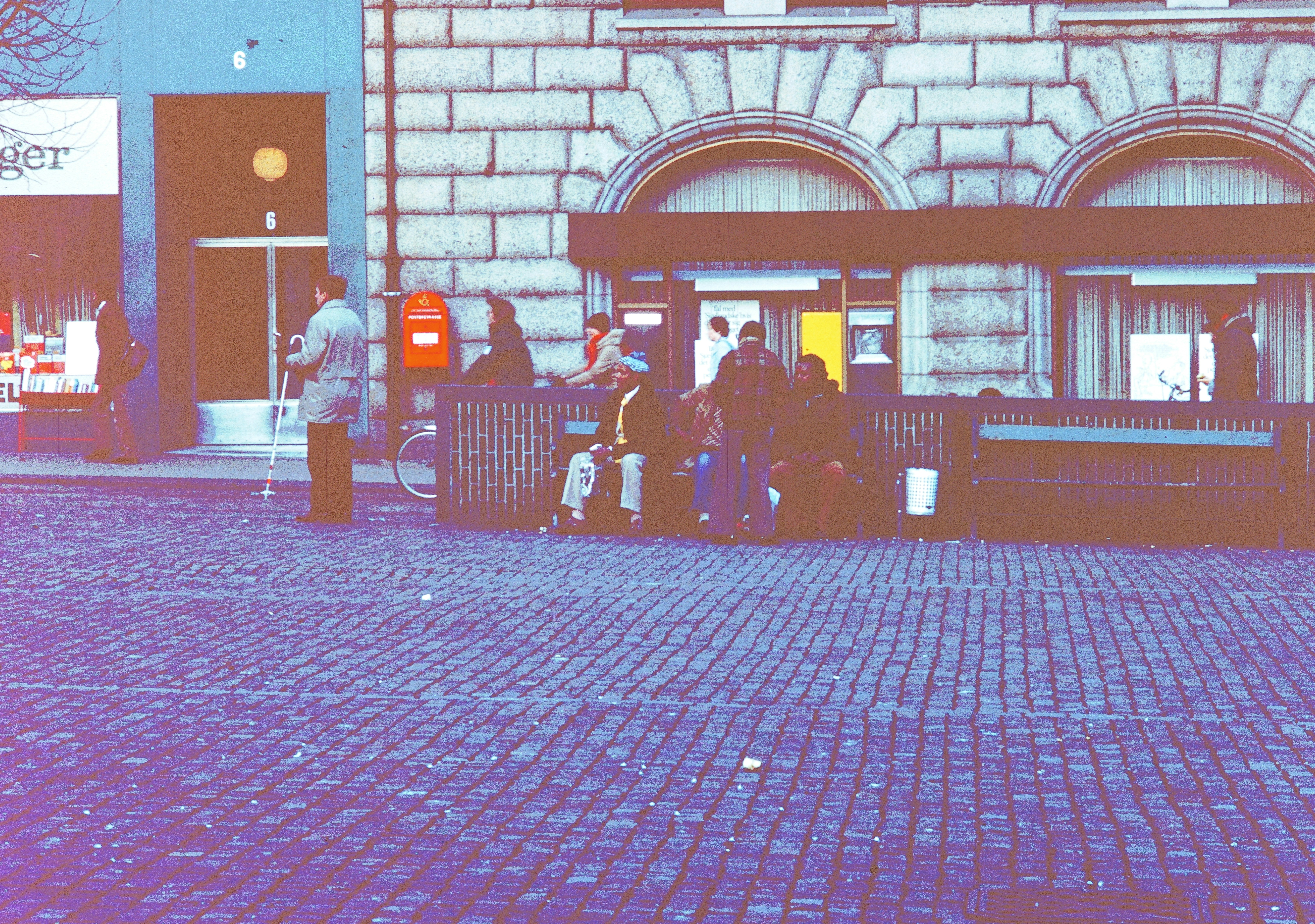 Group on a Cobblestone Street in Front of an Old Stone Building