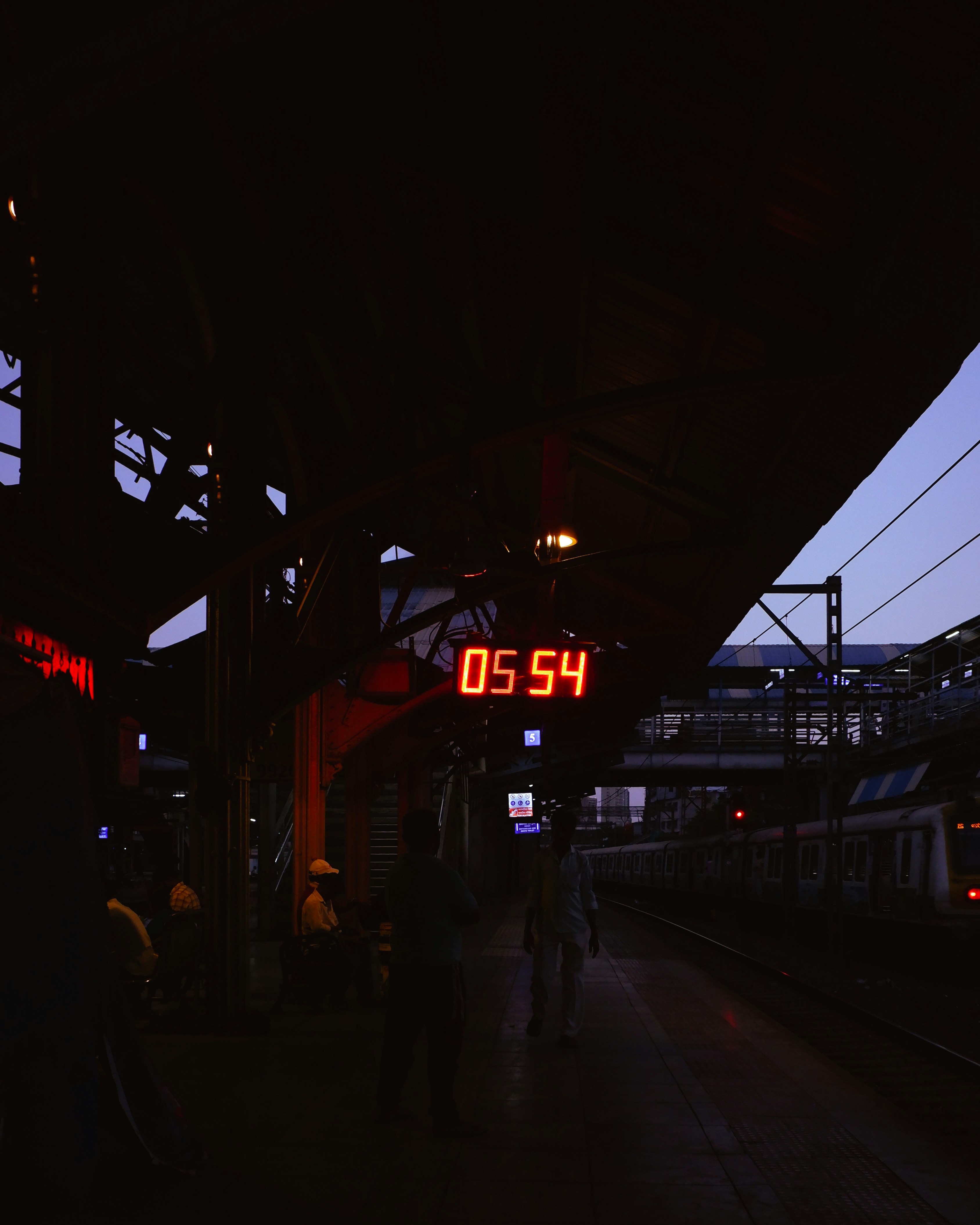 Red Clock at Dusk: A Quiet Platform with Twilight Trains