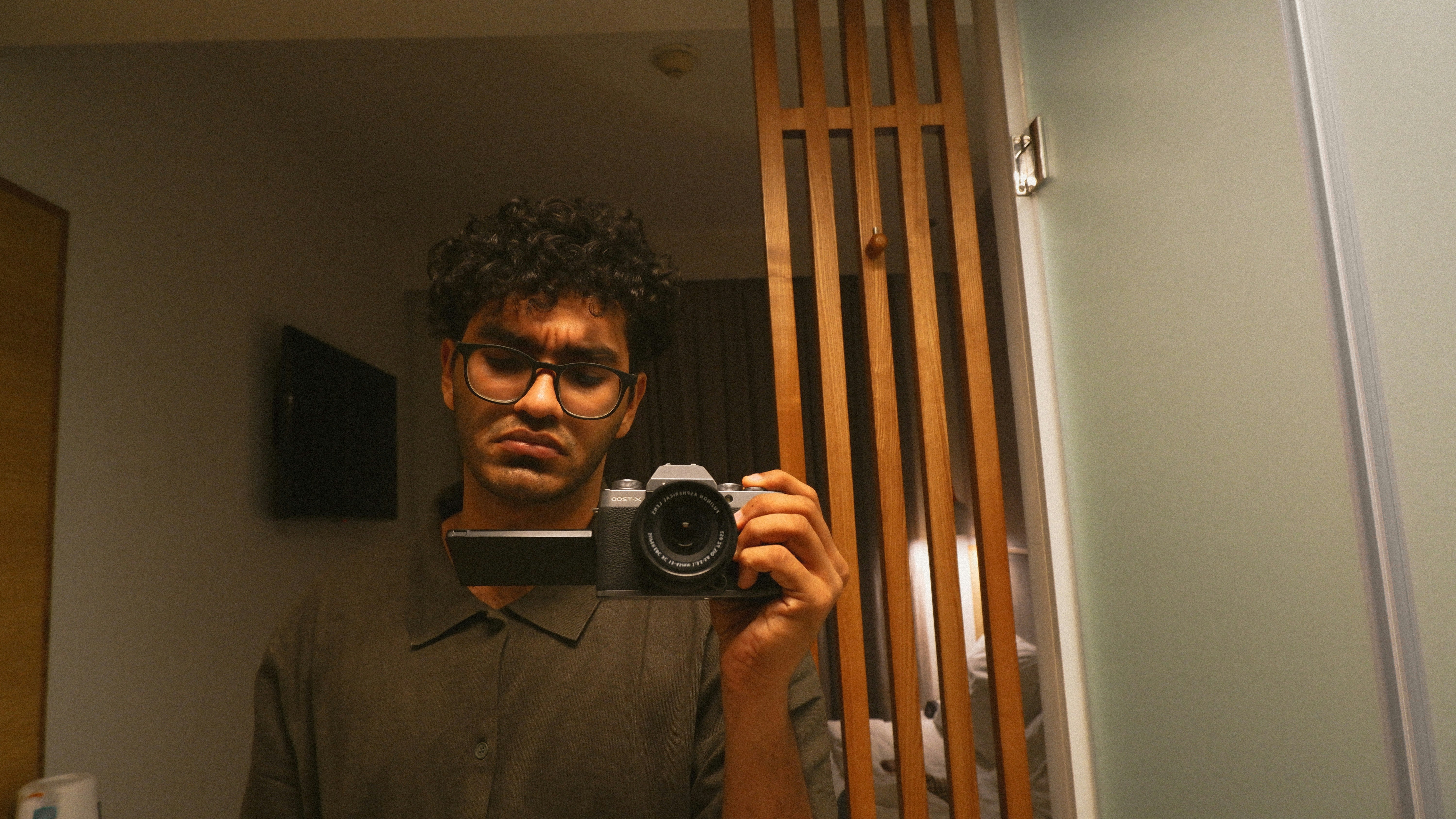 A person taking a mirror selfie with a camera.