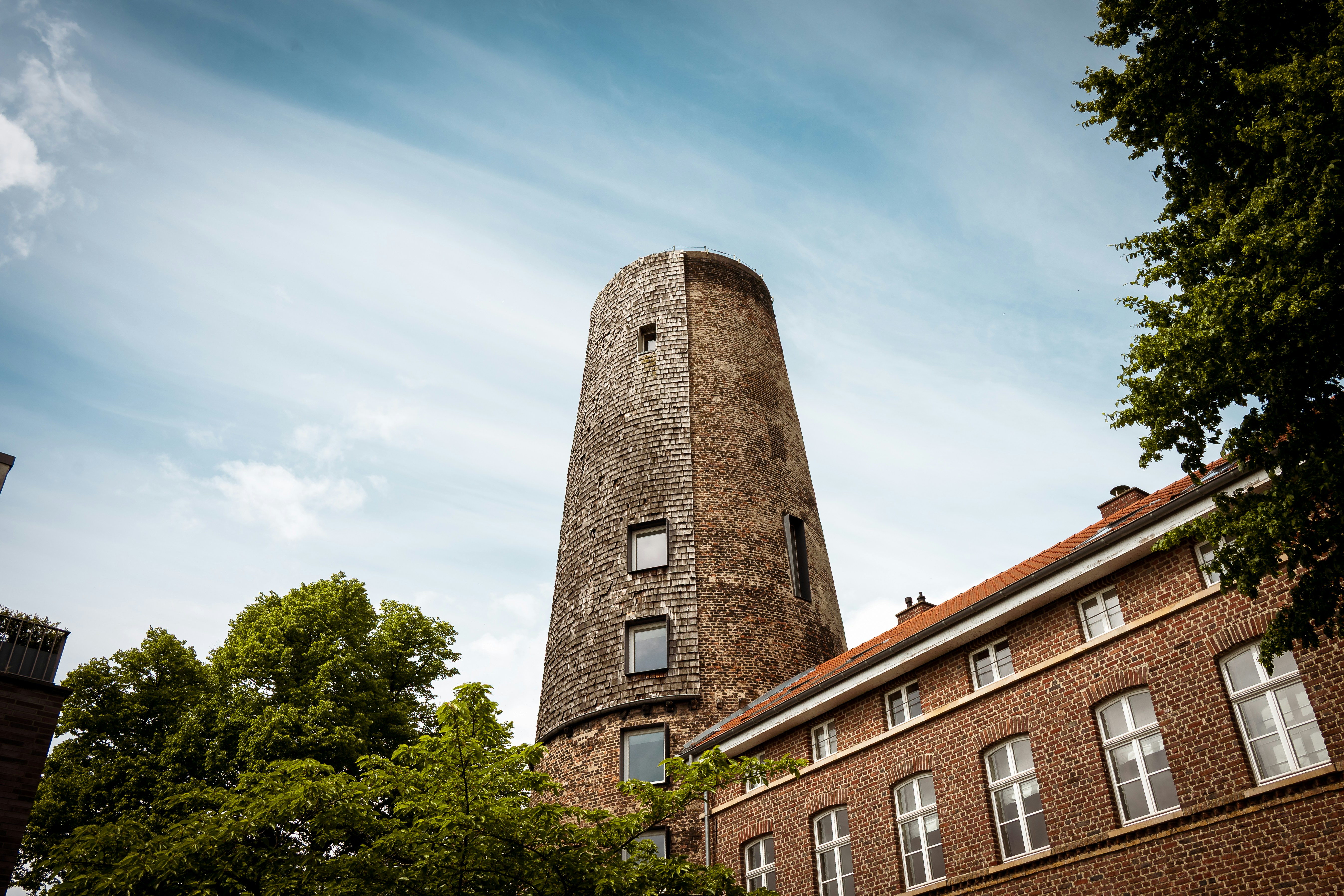 Old Tower Rising Over Brick Annex
