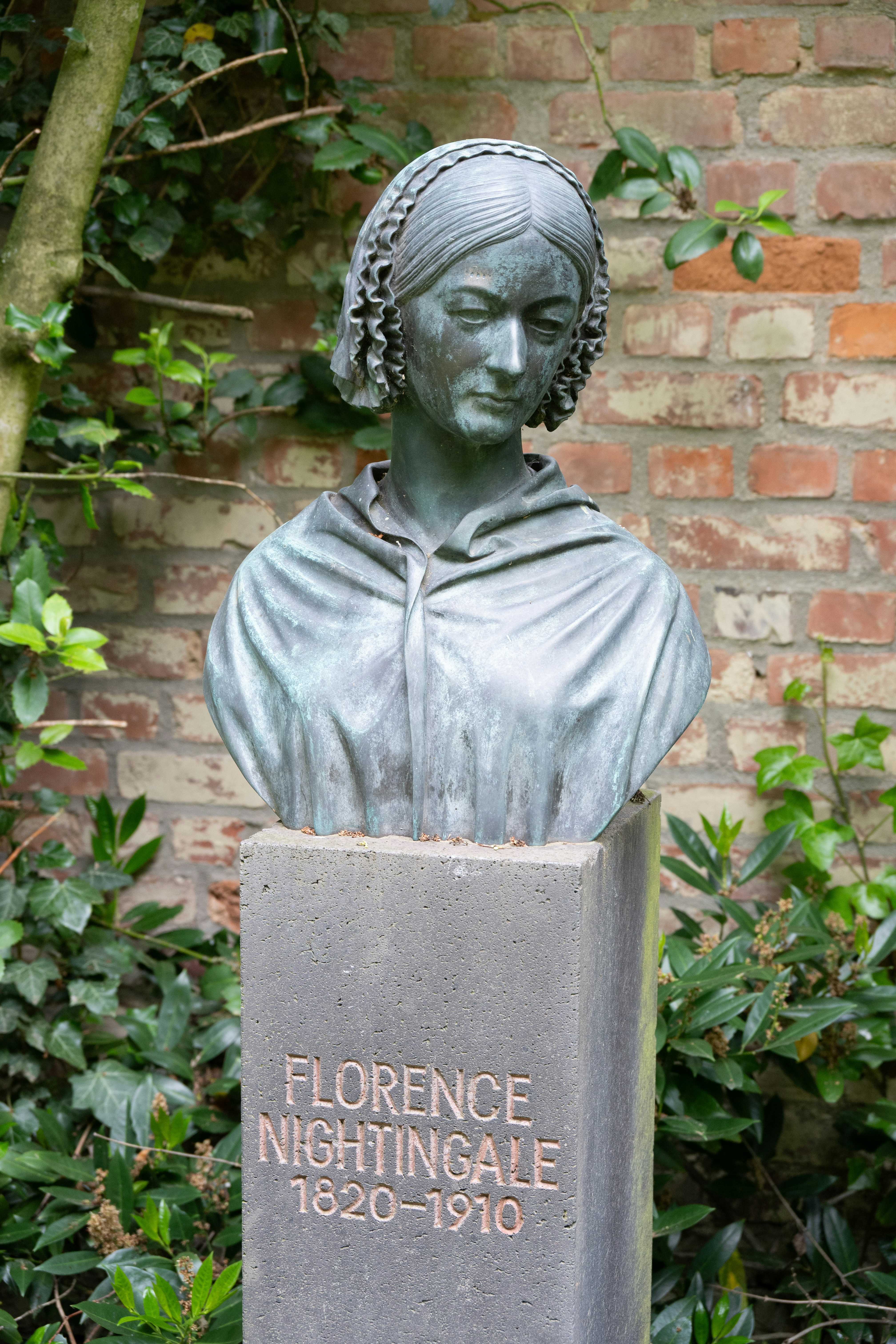 Bronze bust under ivy: Florence Nightingale’s quiet monument in a brick garden