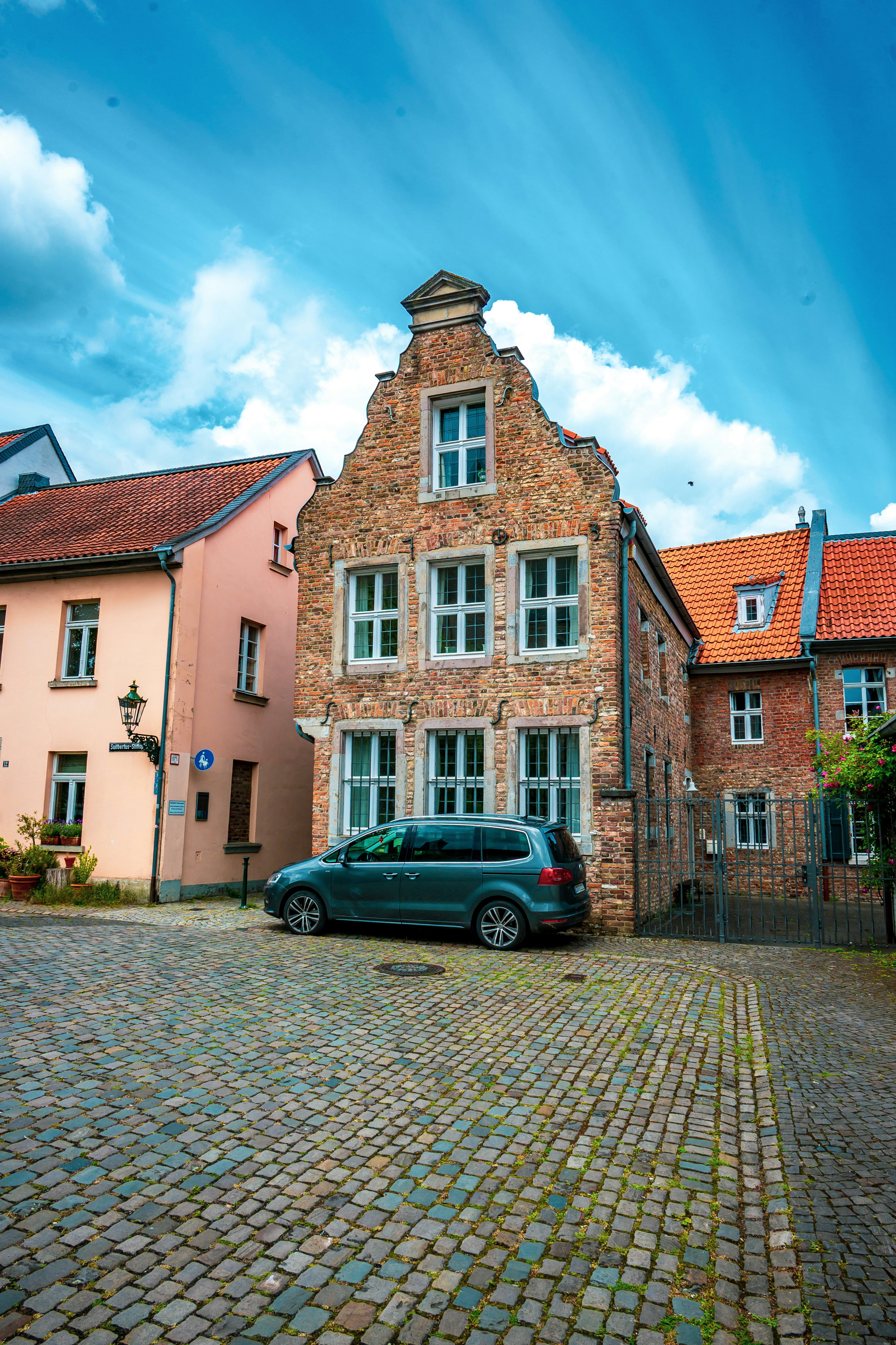 Brick Facade Chronicles: A Quiet Street Under a Looming Sky