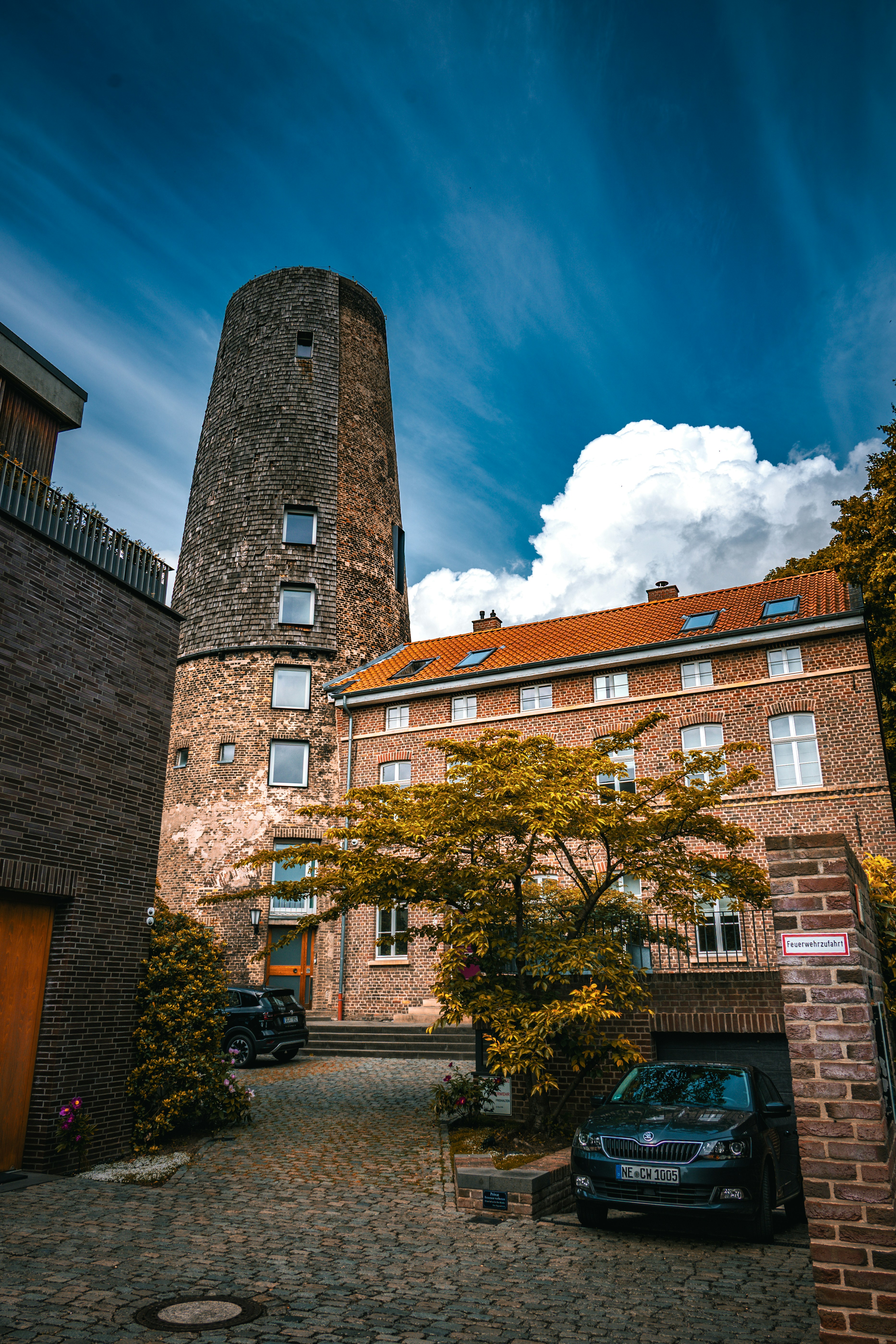 Brick Tower Overlook: A Quiet Courtyard Under Broad Sky