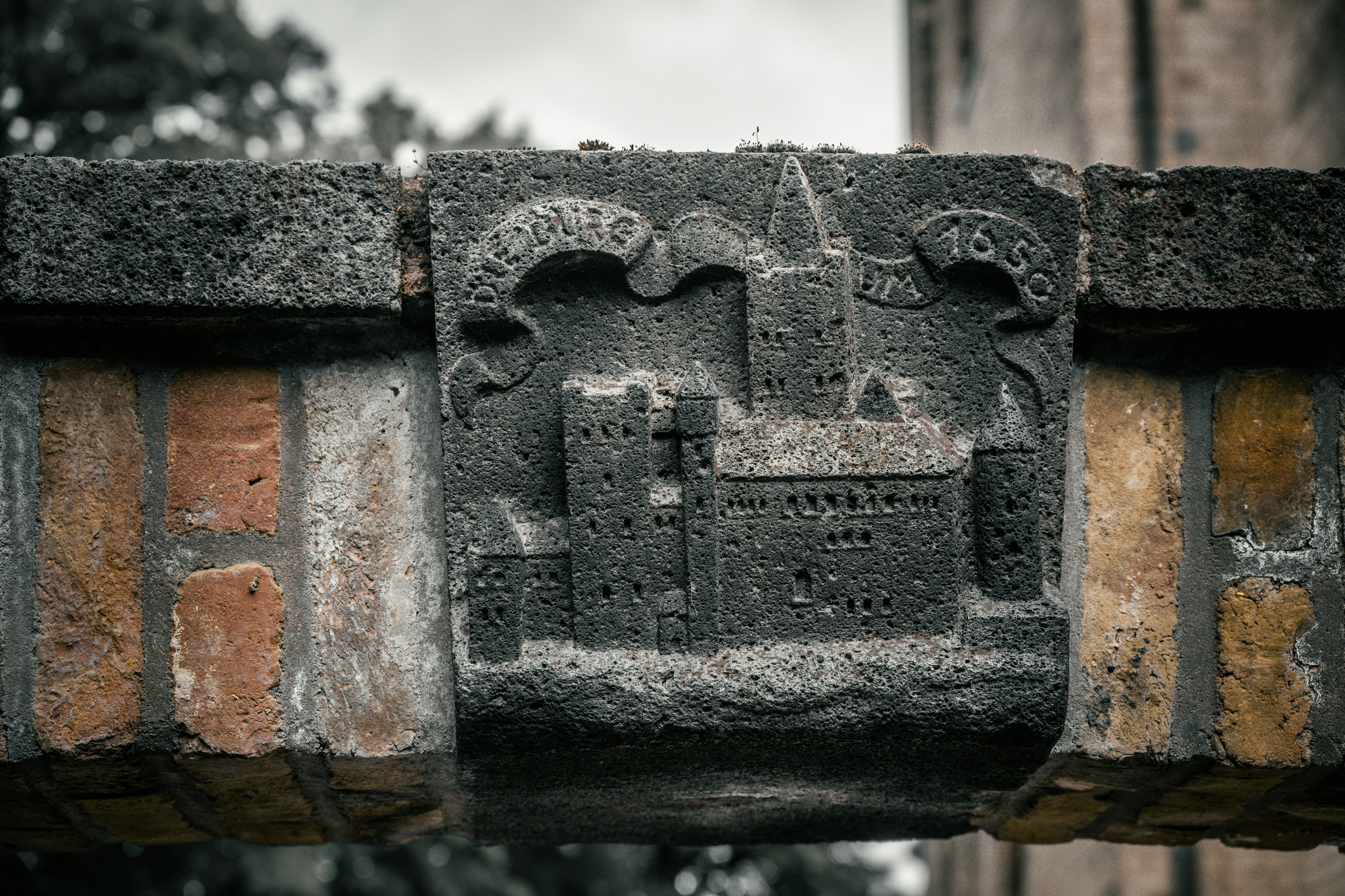 Carved Rivers and Brick: A Heraldic Relief Under a City Bridge
