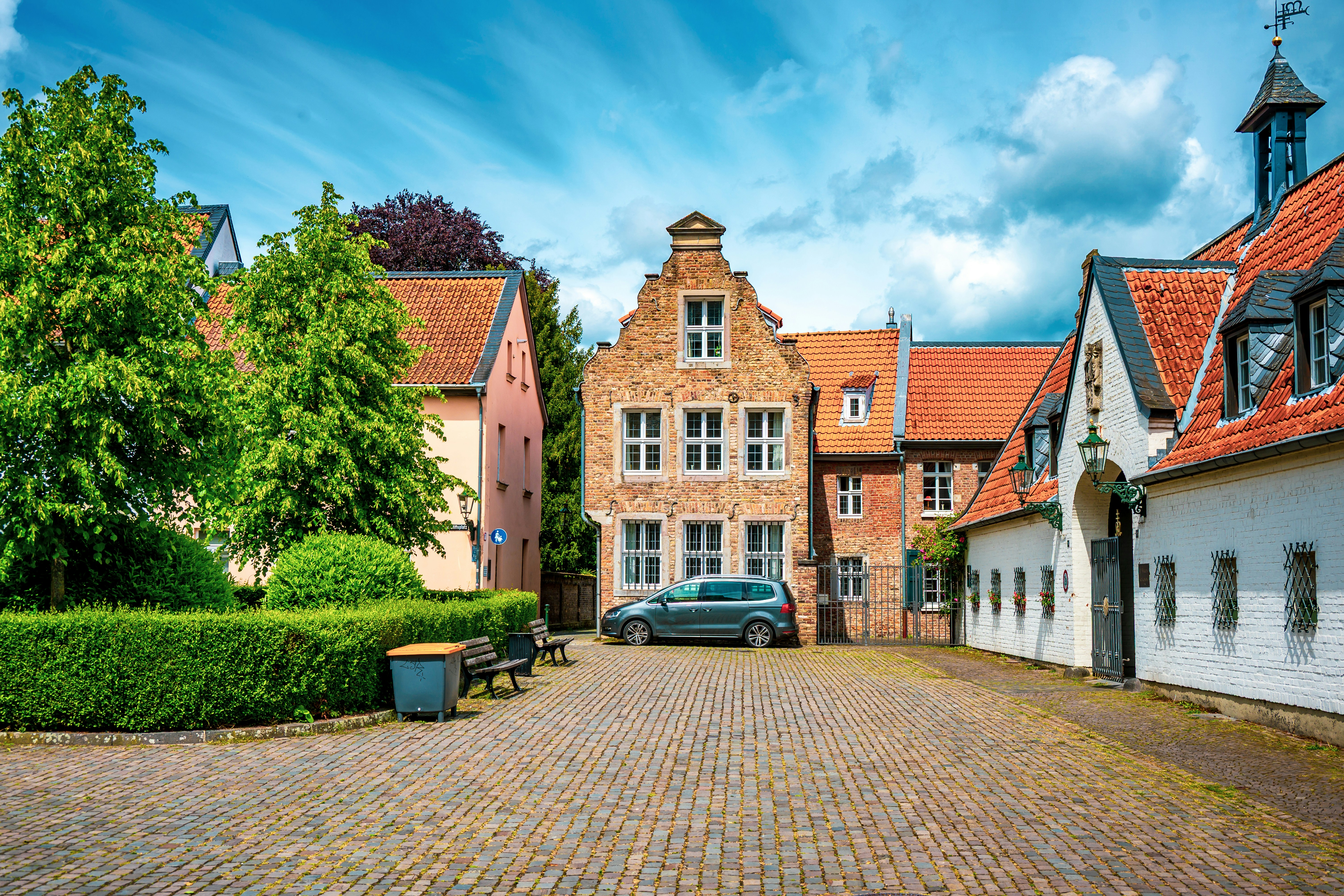 Cobbled Court with a Central Car and Historic Facades