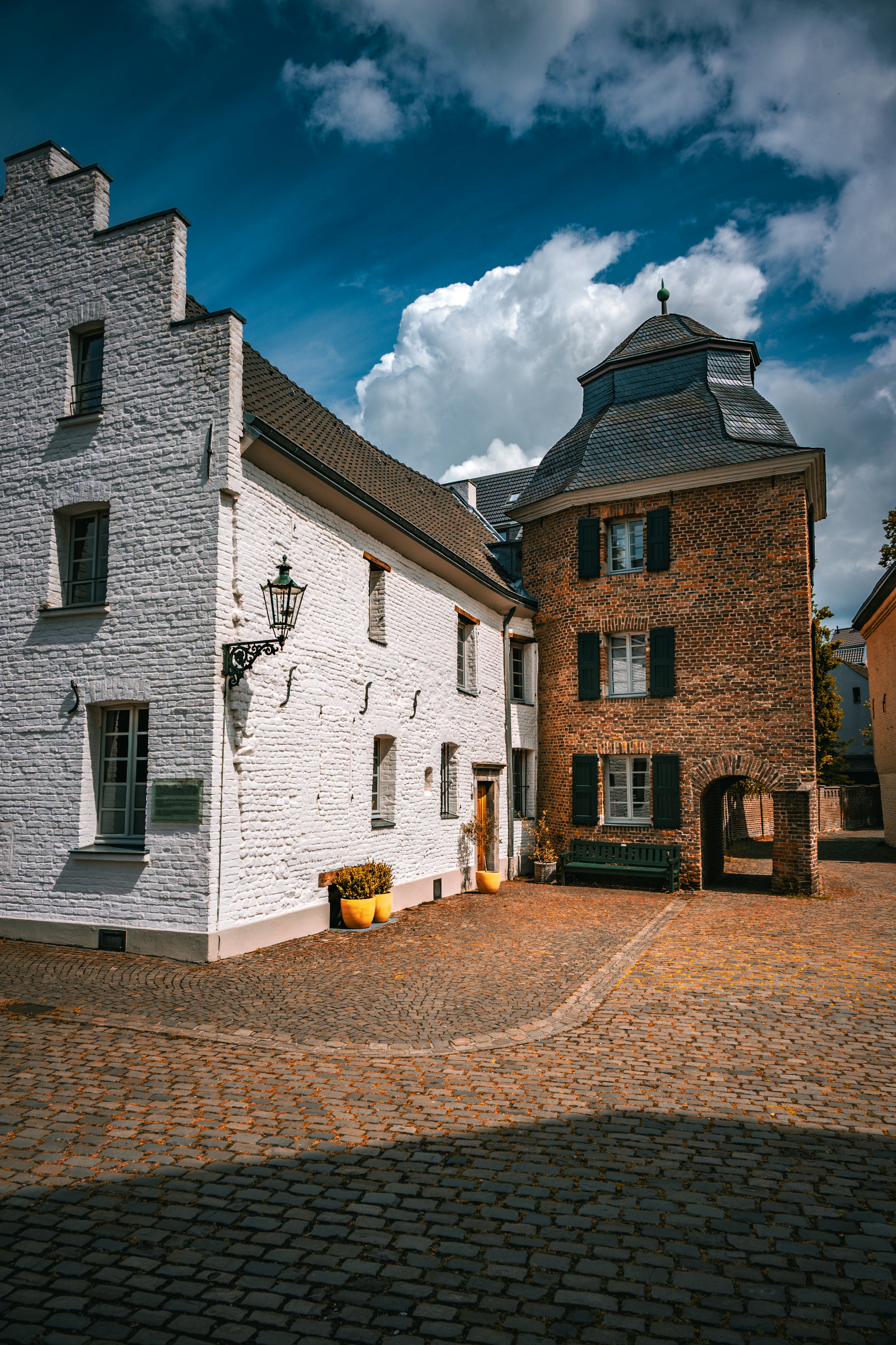 Facade Confluence: A Narrow Street Between White and Brick