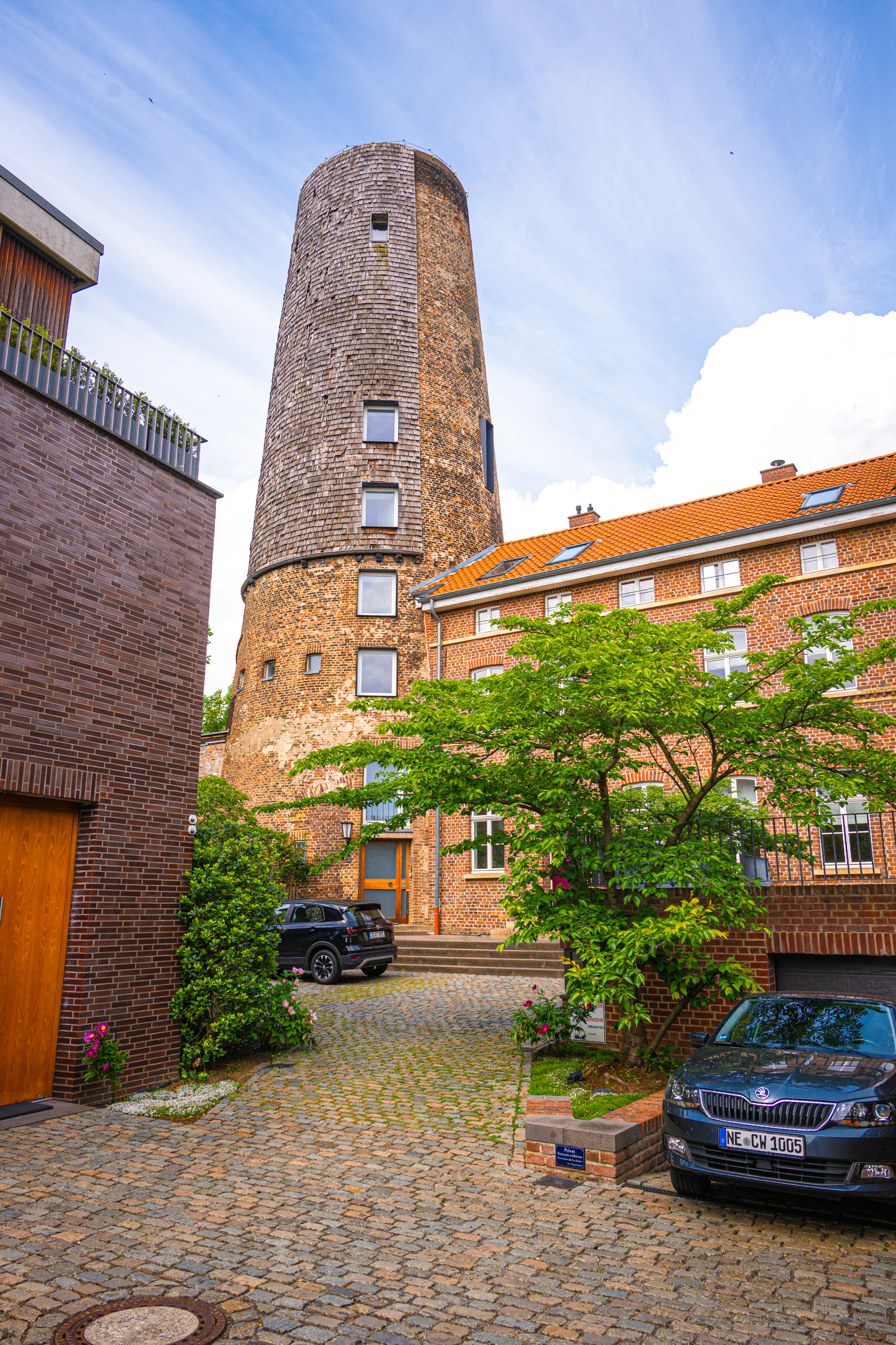 Towered Brick Courtyard: Cobbled Path to a Roundstone Keep