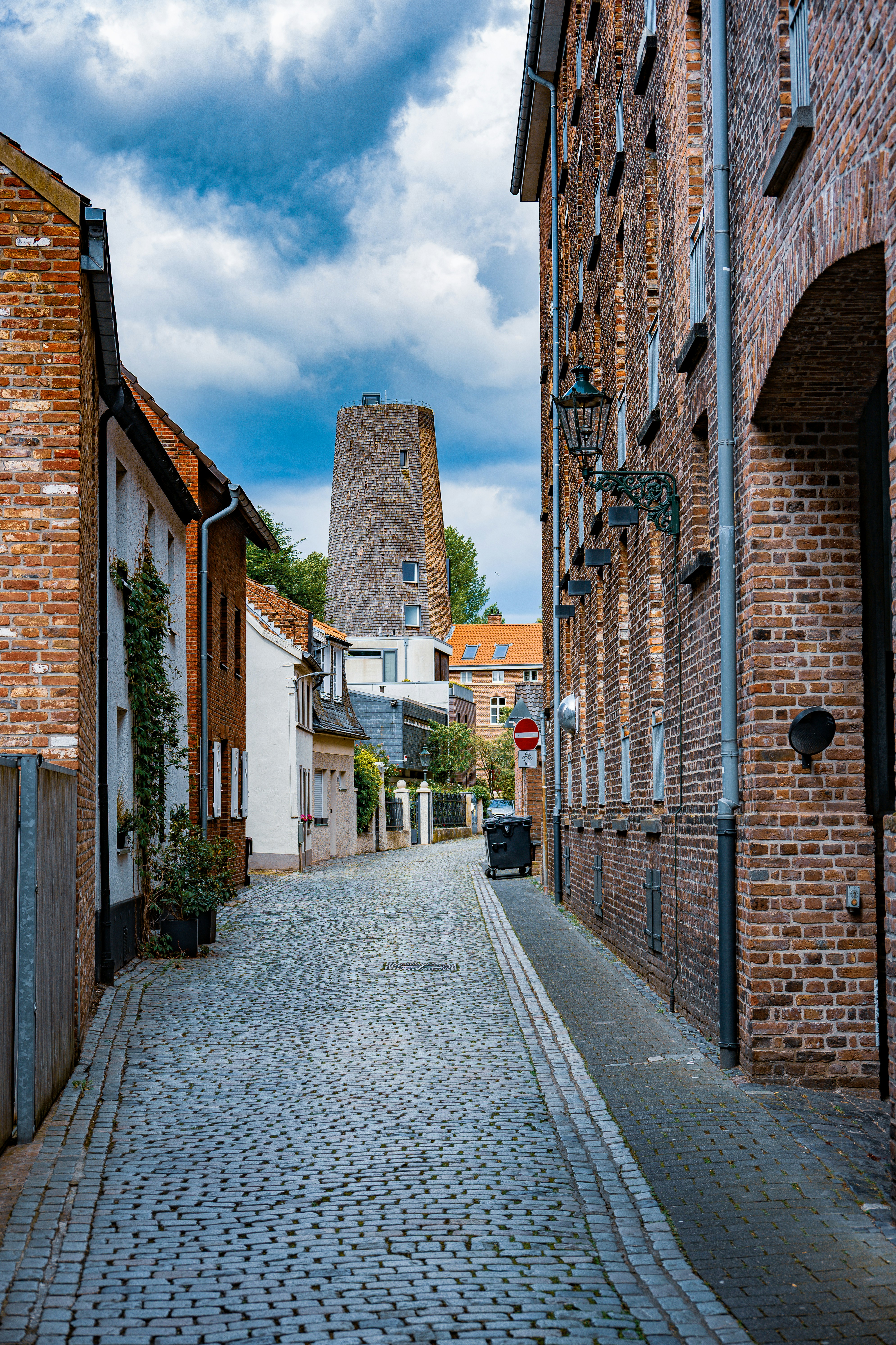Cobbled Street Toward a Towering Quiet