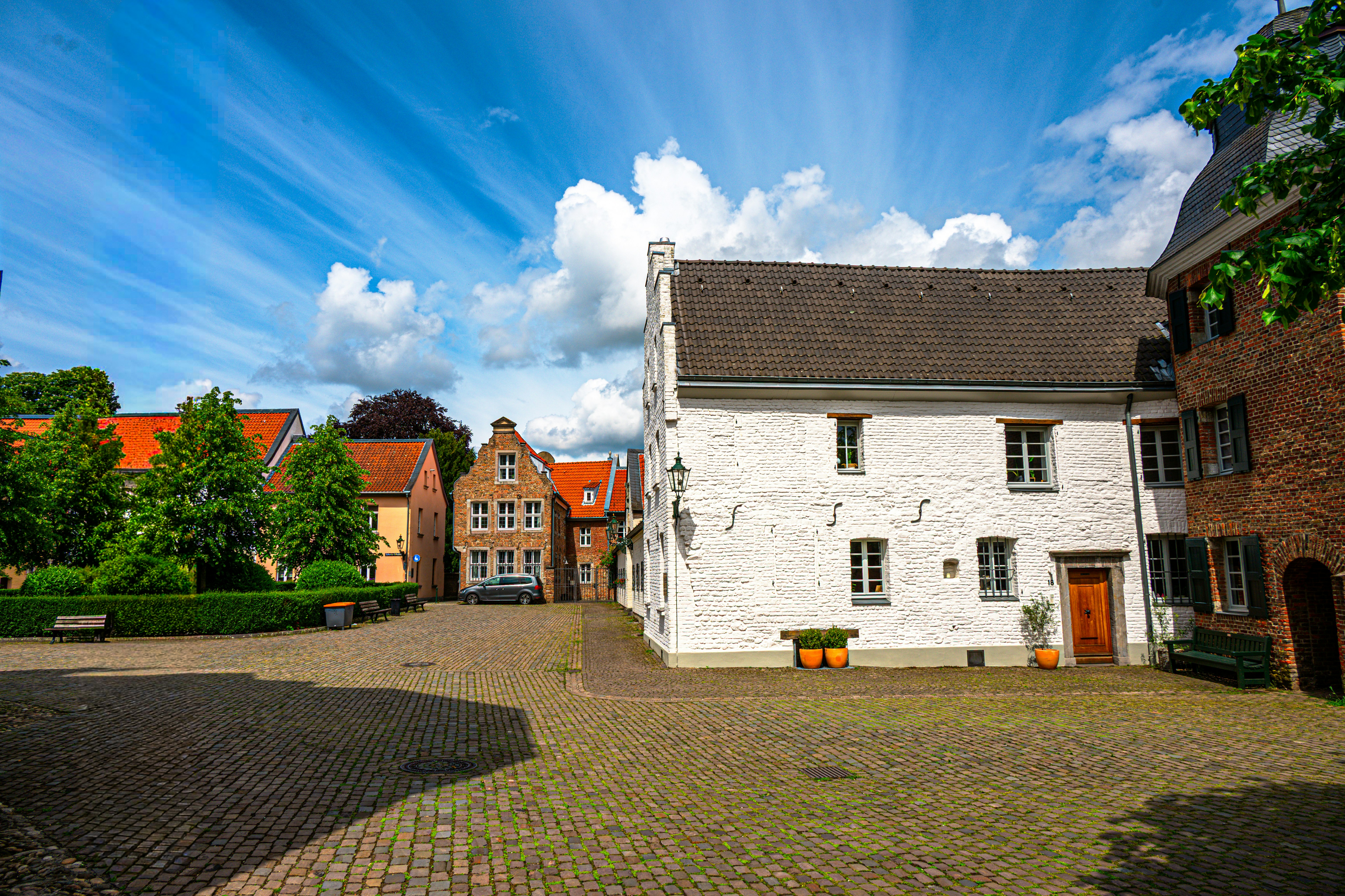 White-walled House at the Sunlit Town Square