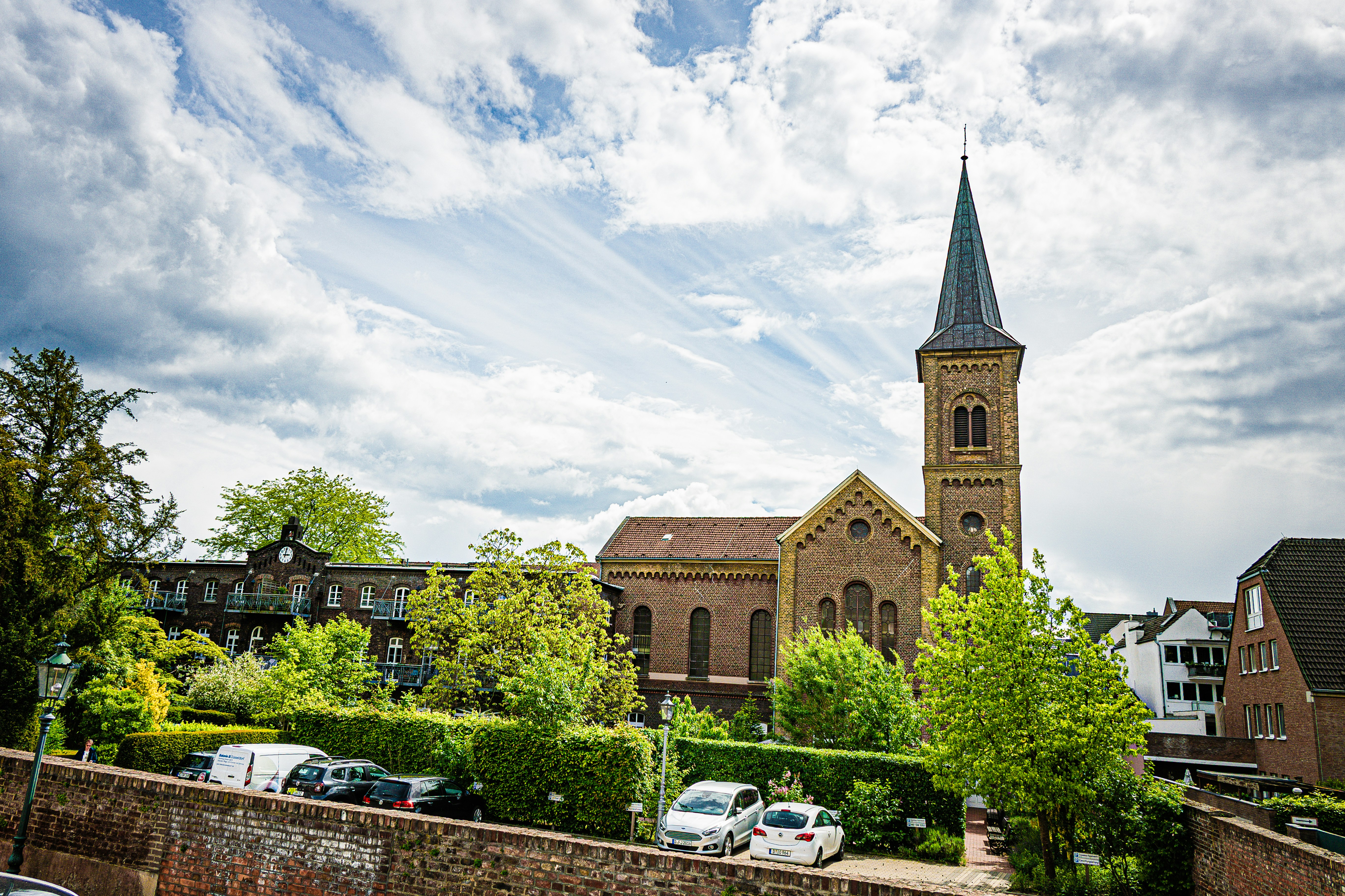 Village Church Steeple Rising Over a Tree-lined Square