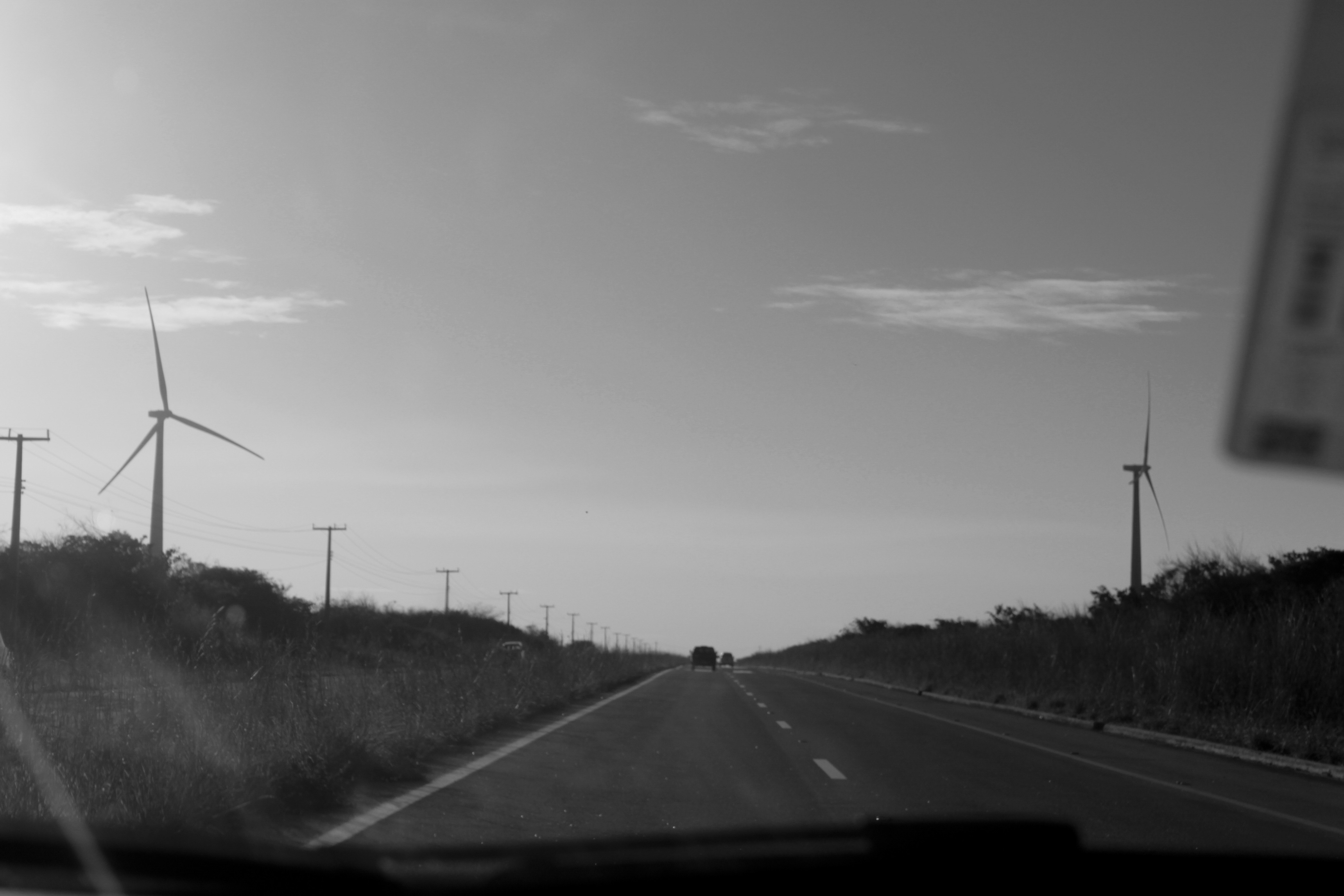Long Horizon: Wind Turbines and Road Fade into Distant Quiet