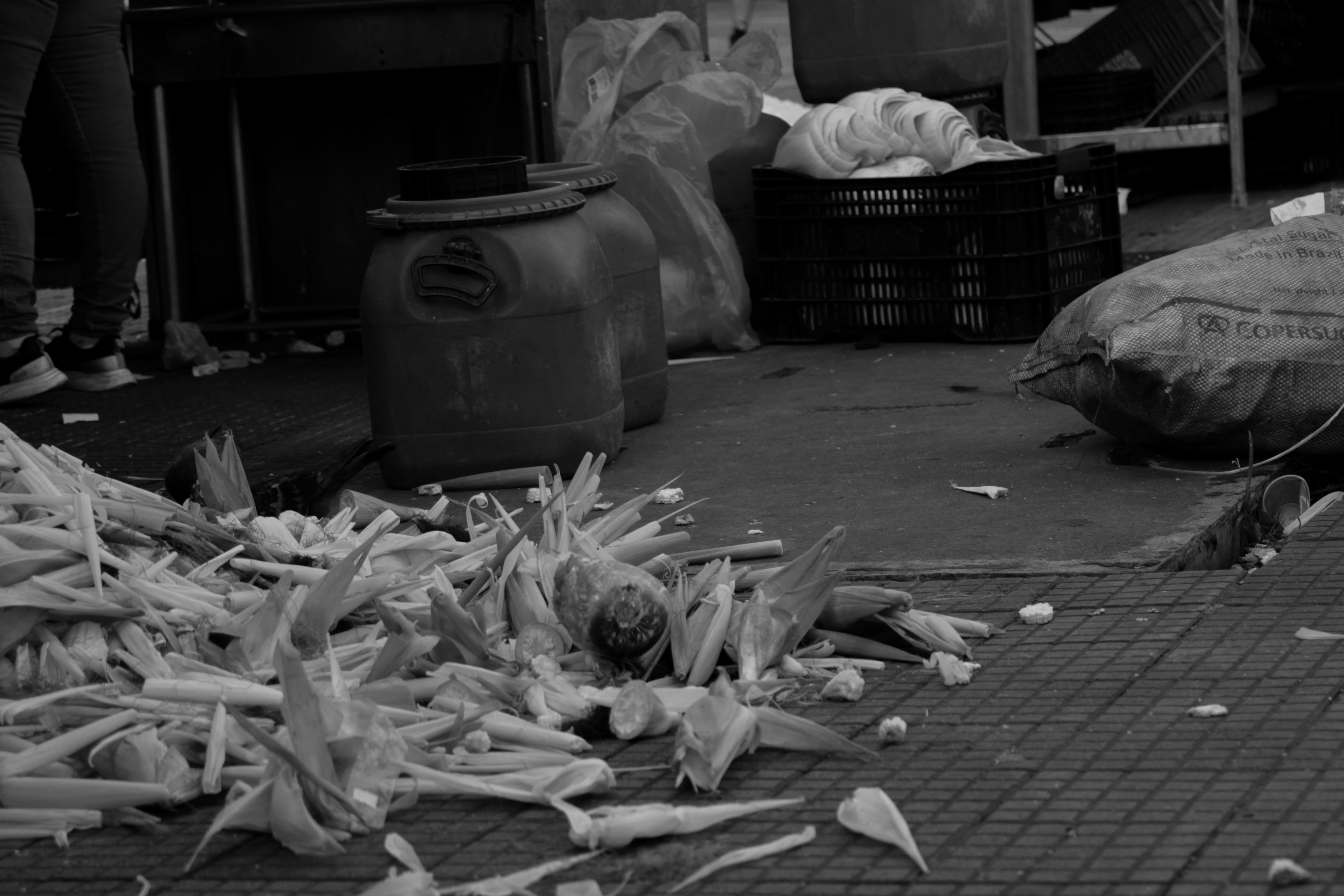 Cornsilk Echoes: Corn Hulls Scattered Beneath a Market Stall
