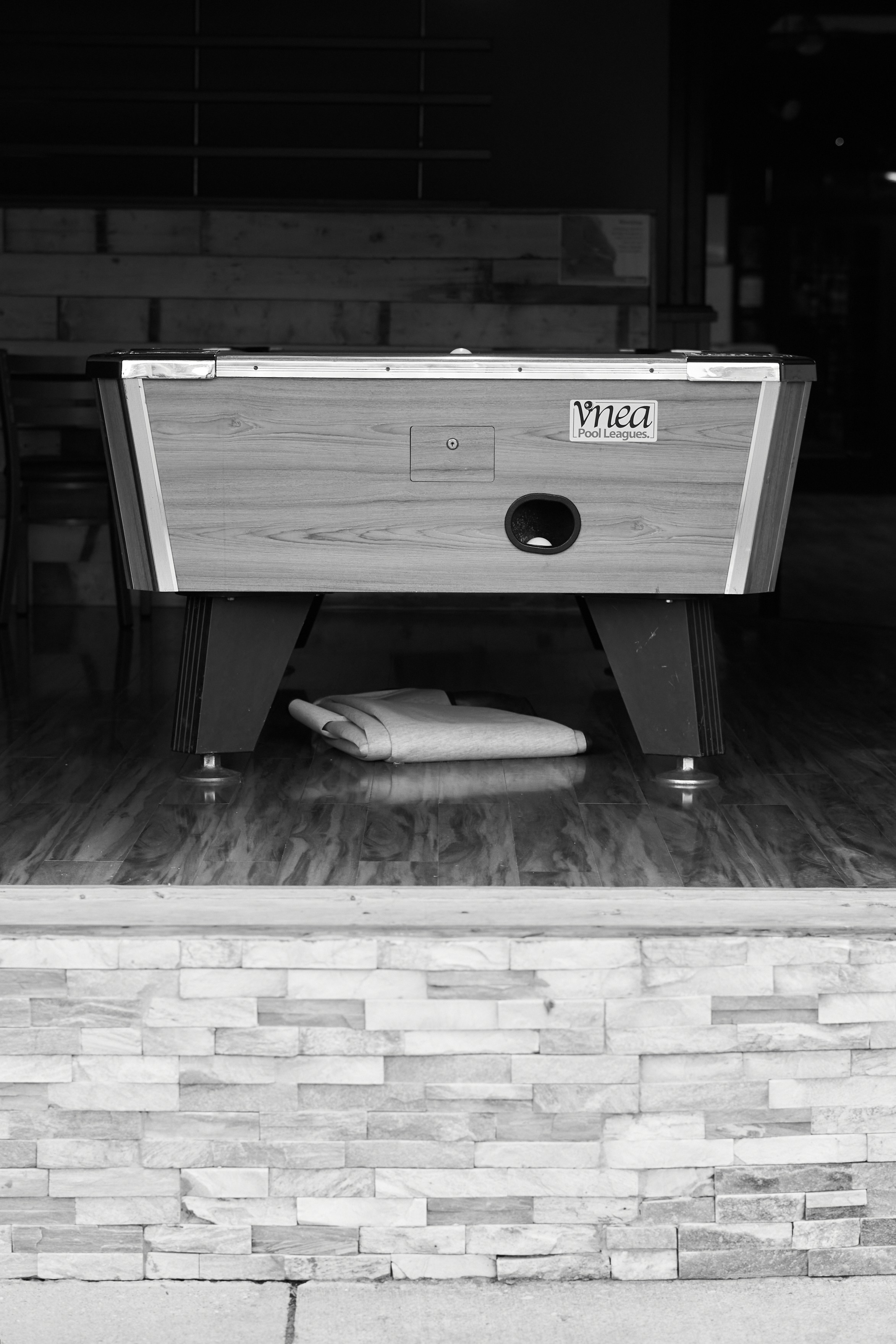 FreePlay at the Edge: A Wood-Panel Billiards Table in Low Light