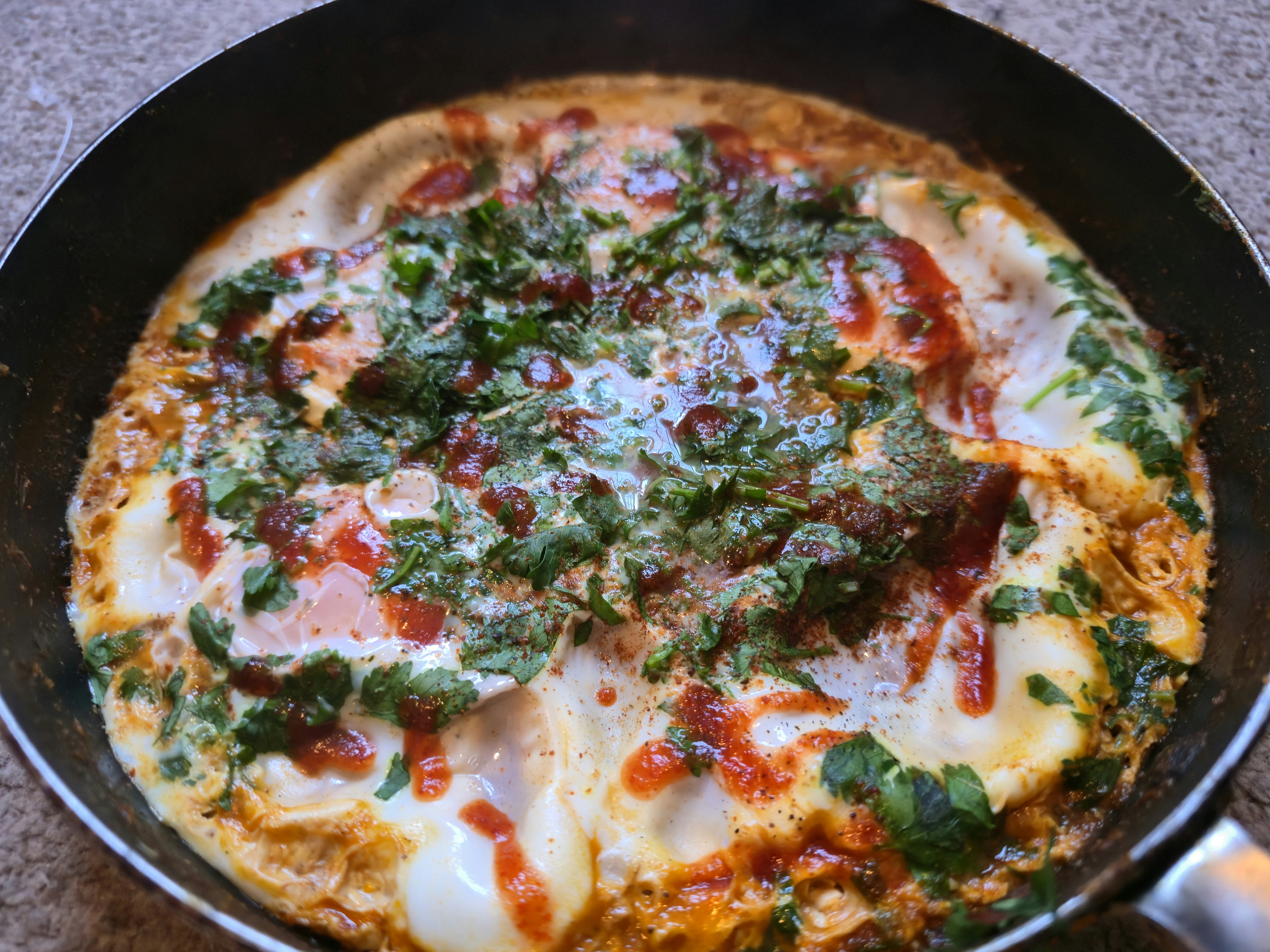 Crispy skillet shakshuka meets herb-flecked fried eggs