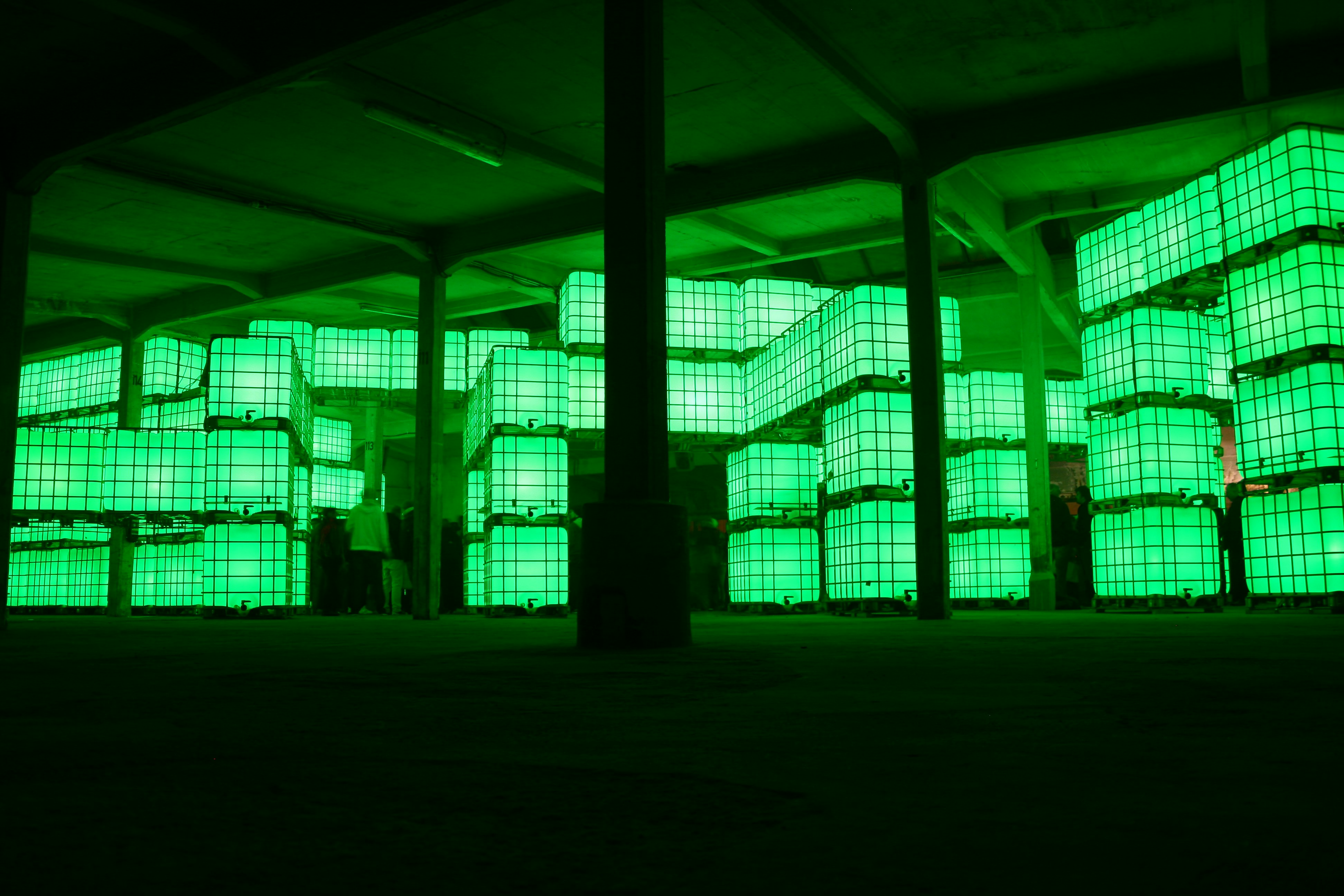 Emerald Glow: Stacked Light Blocks in a Quiet Warehouse
