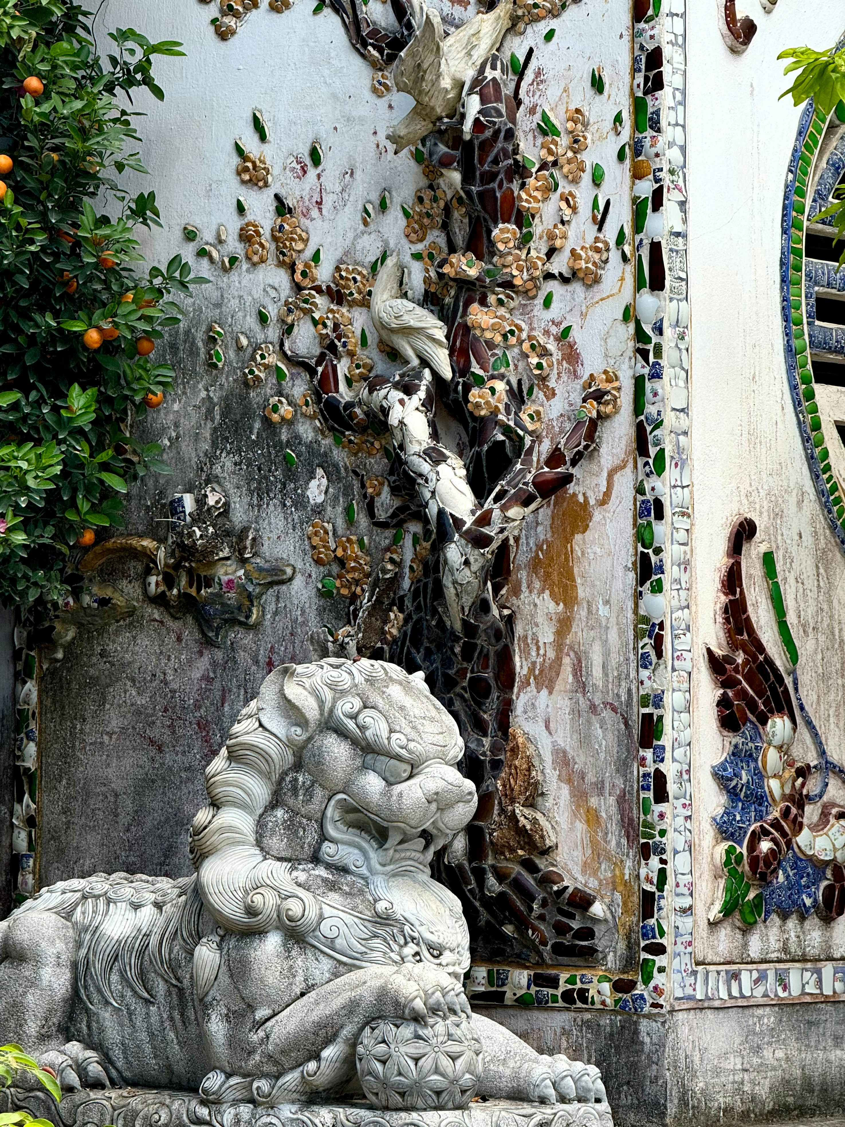 Dragon Lion Statue Amidst Fractured Mosaic Garden