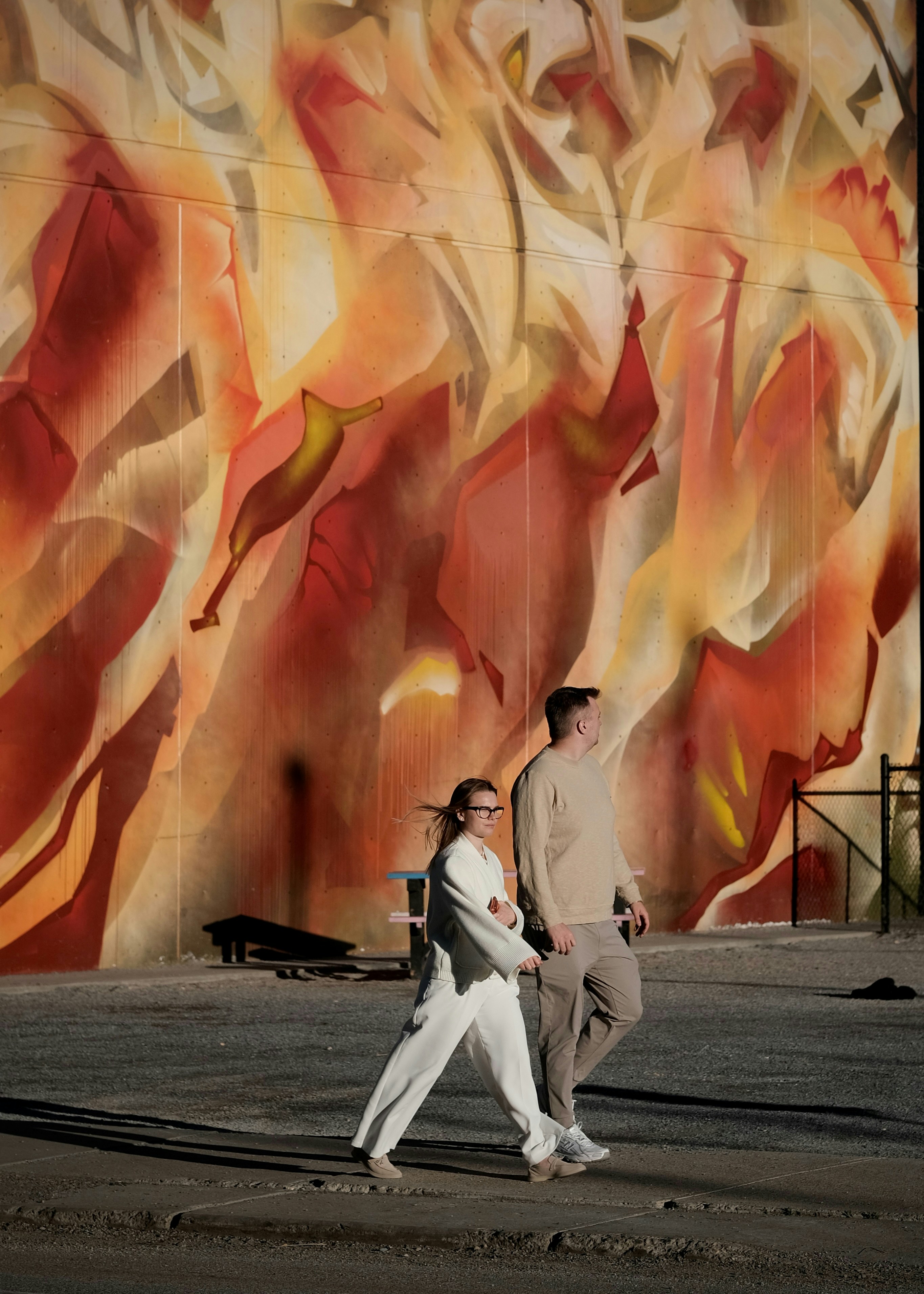 Couple in Motion Against a Fiery Wall