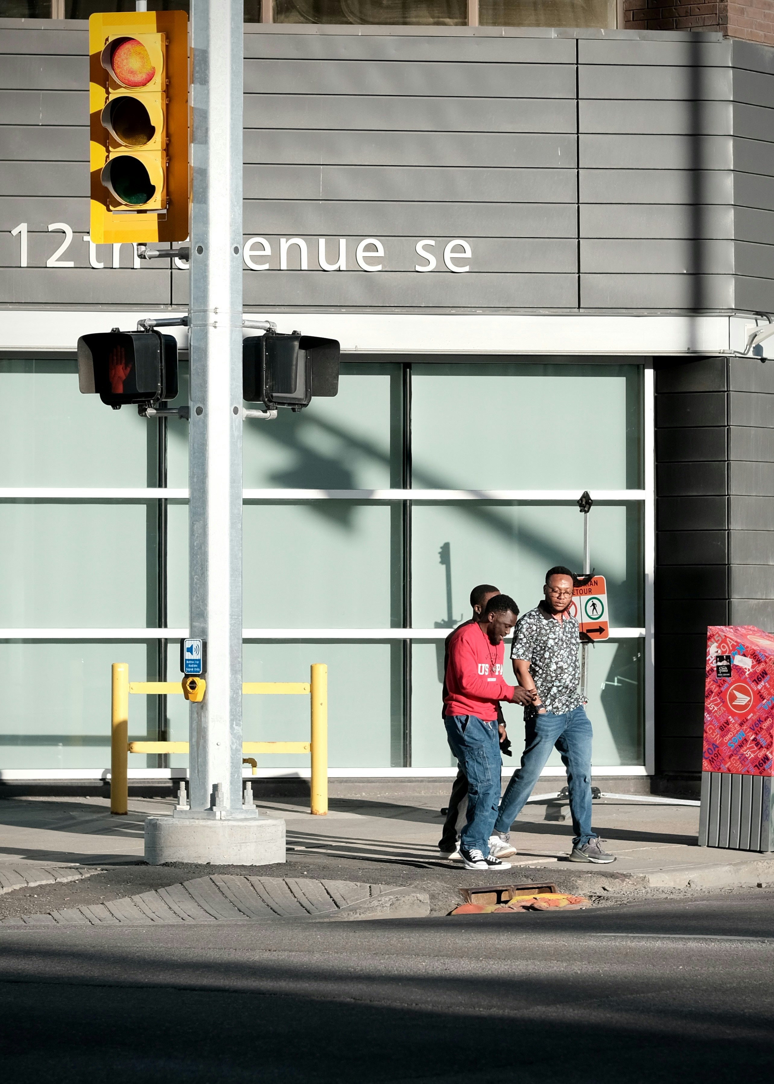 Three Friends on a City Street Beneath a Glass Facade