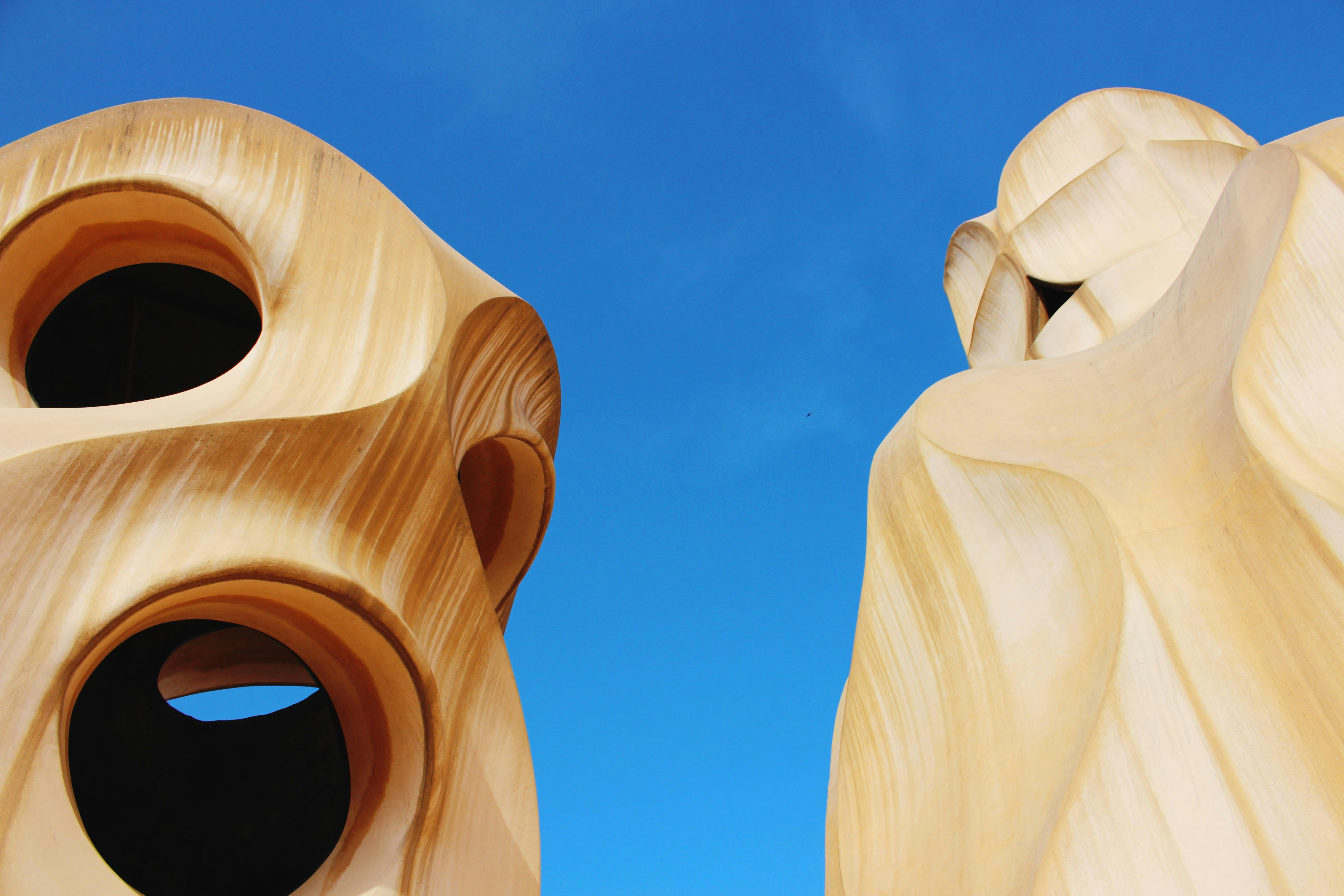 Curves in sandstone: a dialogue of sculpture against a cobalt sky
