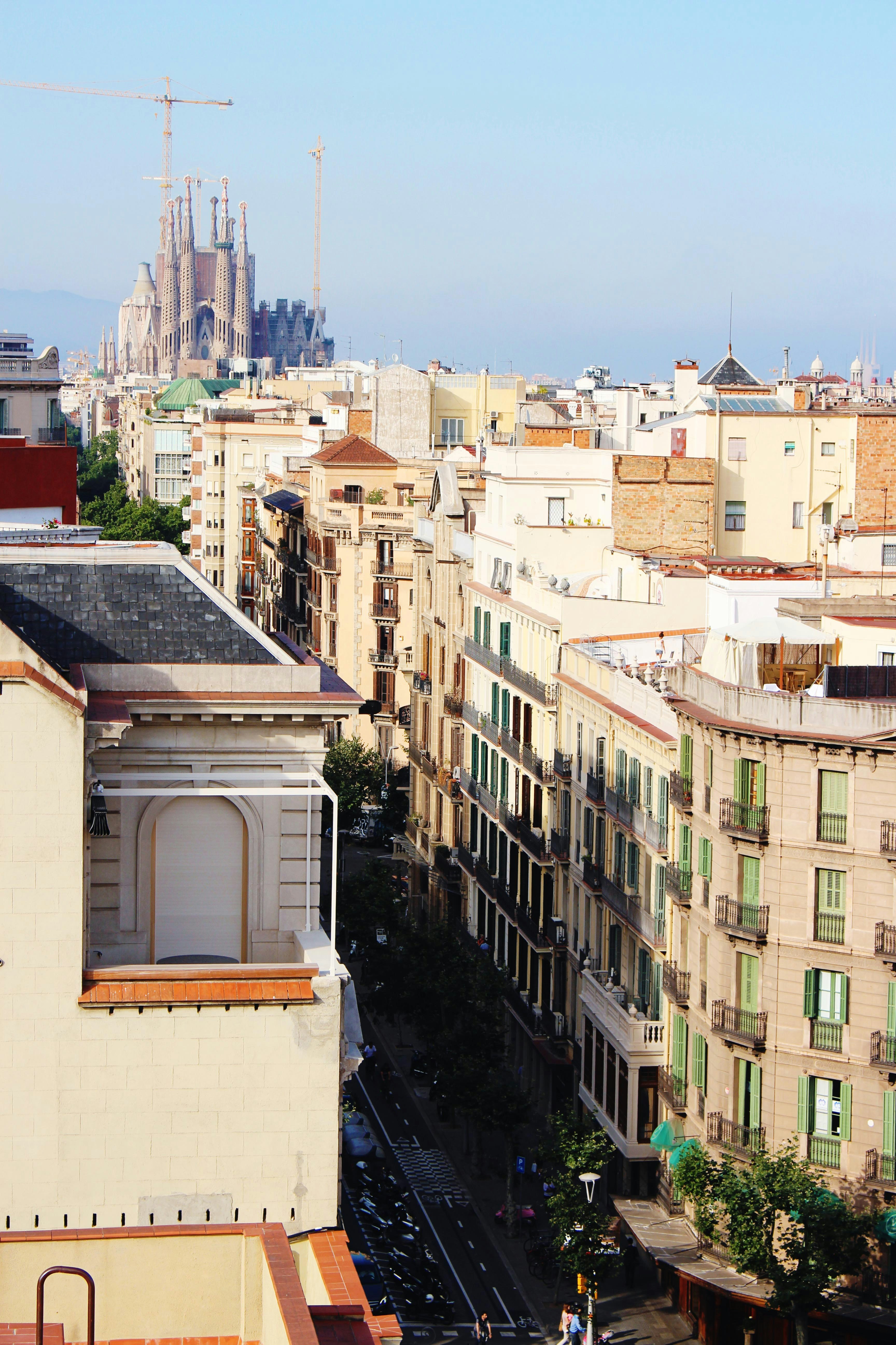 Urban Reverie: Sunlit Streets Framing Sagrada Silhouettes