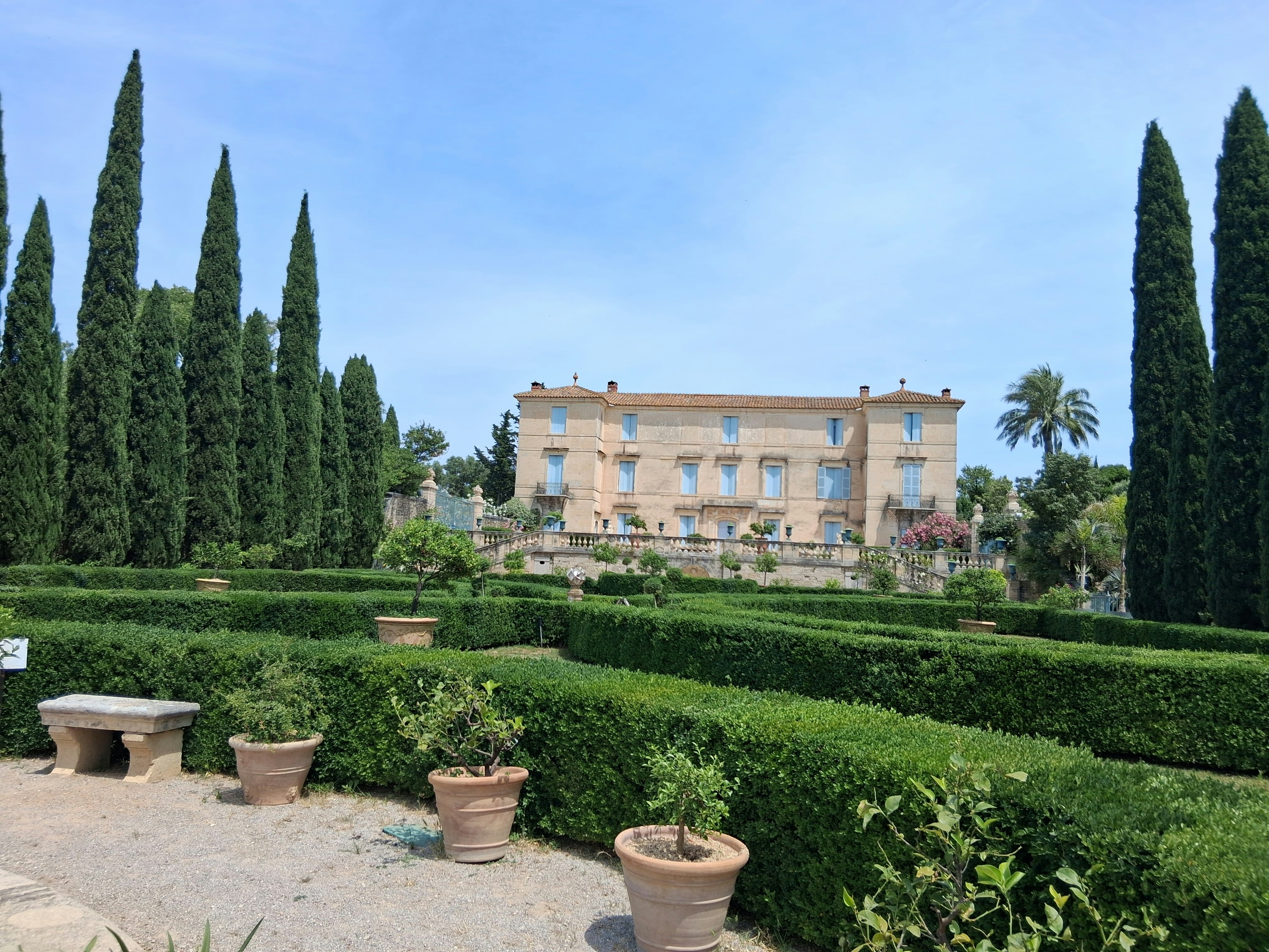Terraced Parterres and a Stone Villa Under a Blue Sky
