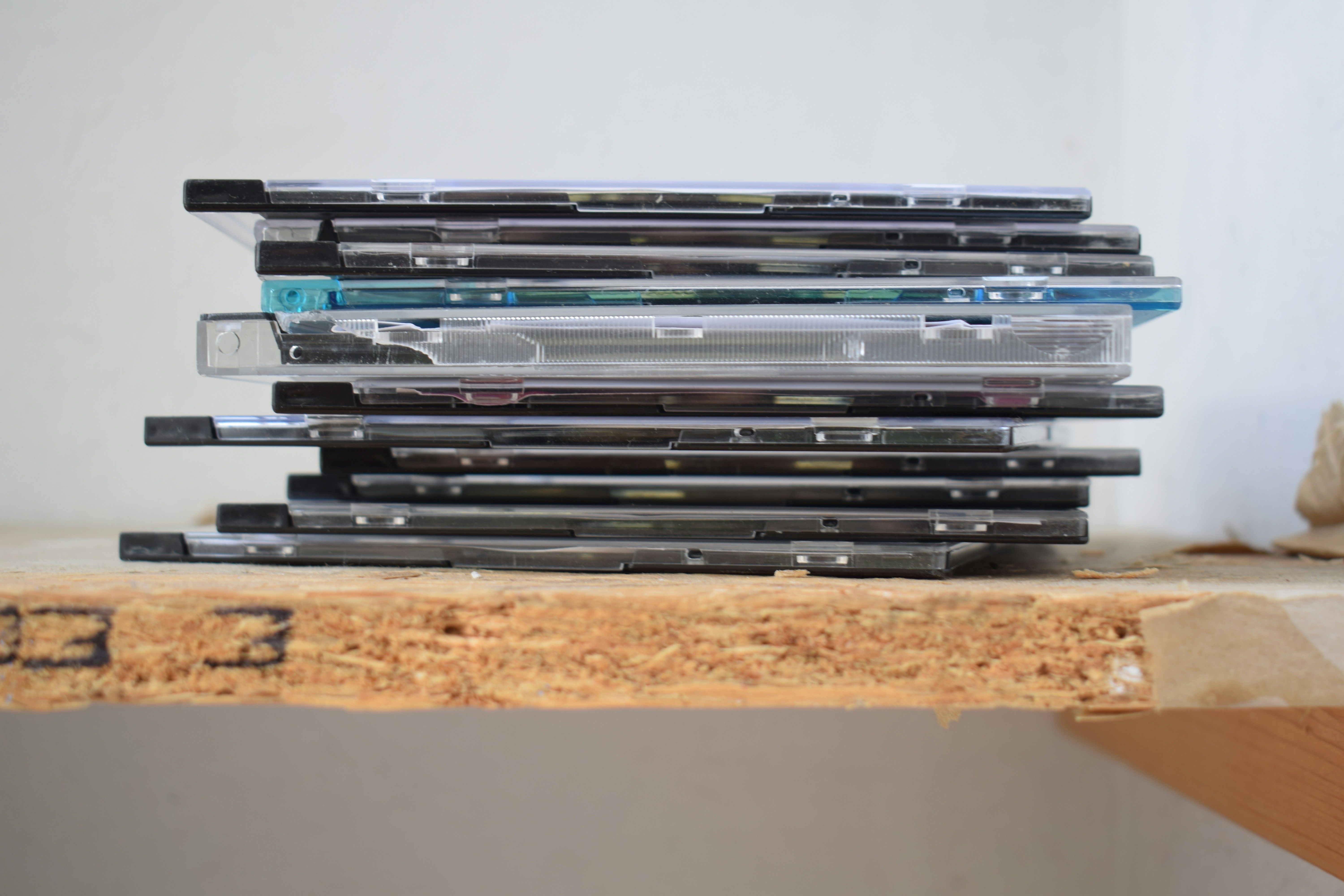 Stacked Shadows: A Quiet Tower of Discs on Weathered Wood