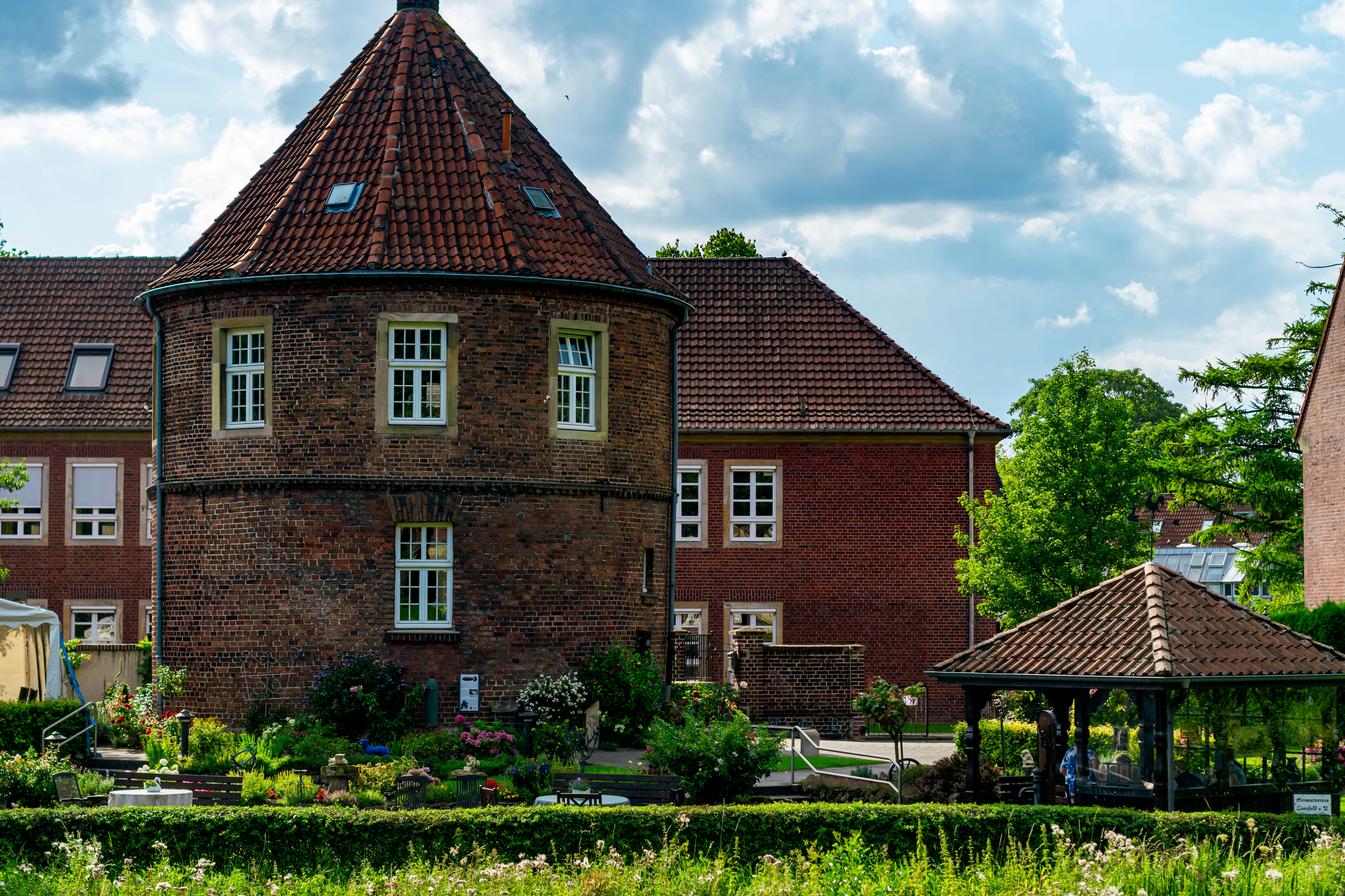 Brick Turreted House Overlooking a Verdant Courtyard