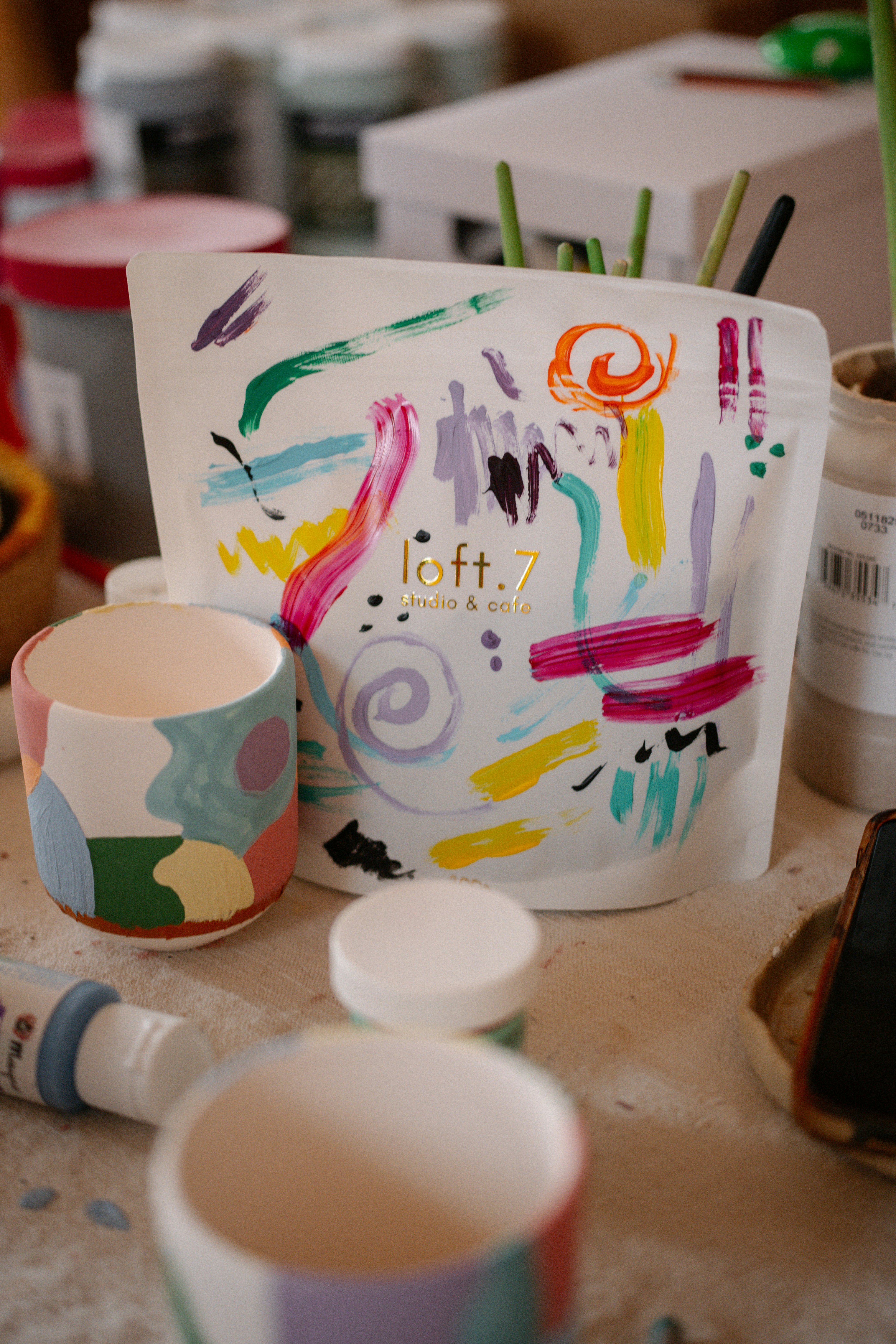 Colorful ceramic cafe scene with abstract packaging as centerpiece