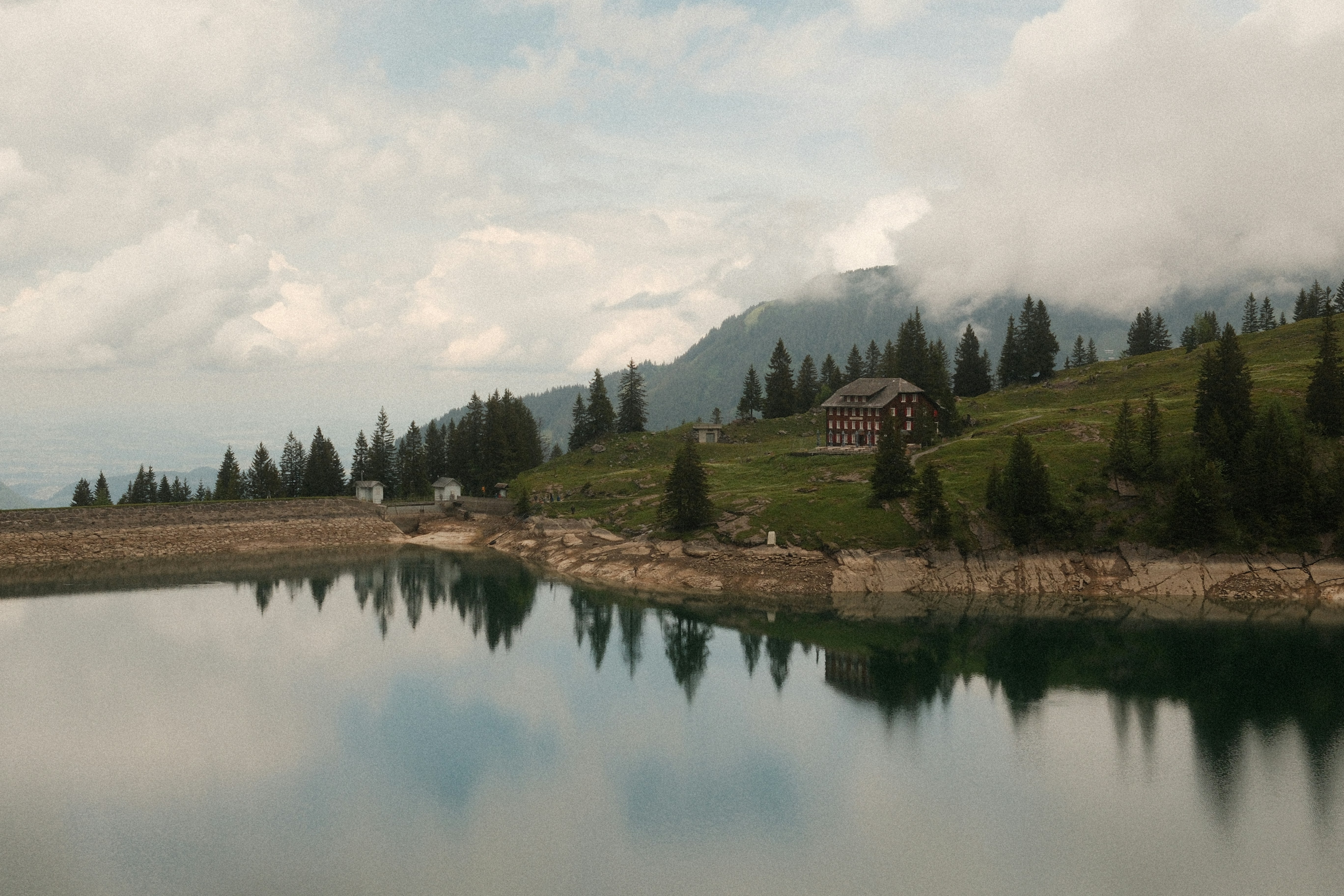 Reflected Alpine Cabin Beside Serene Lake