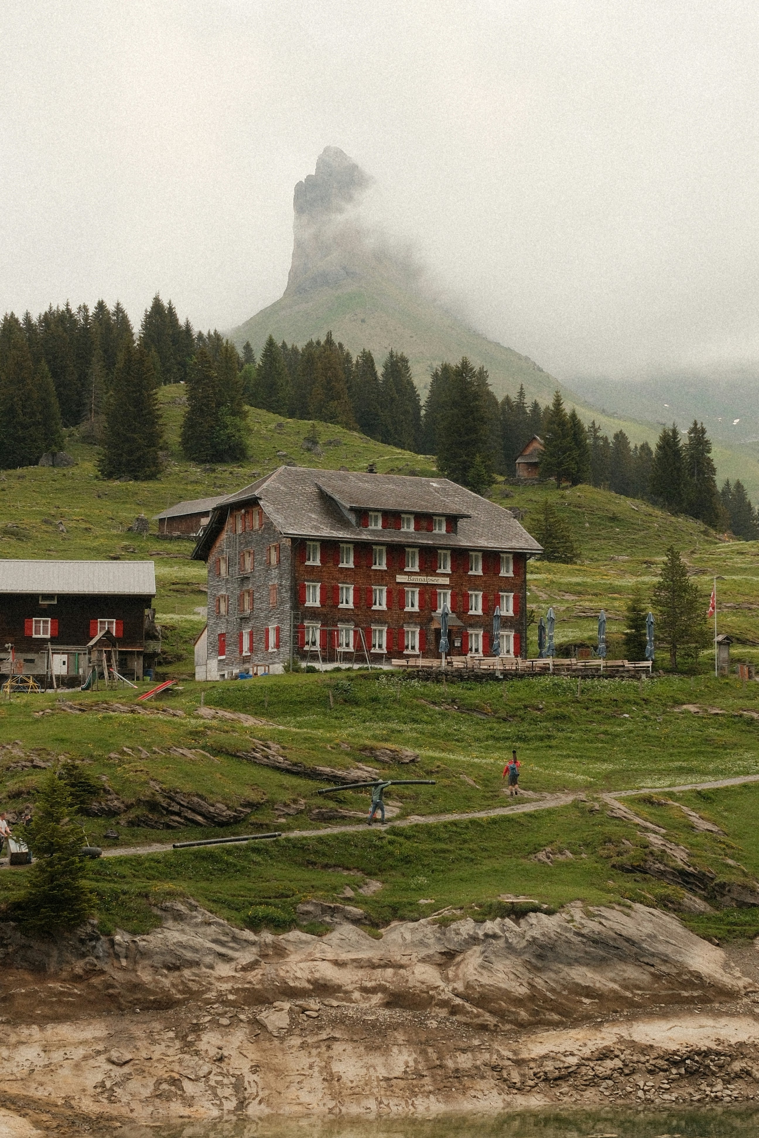 Rustic mountain lodge under a misty peak