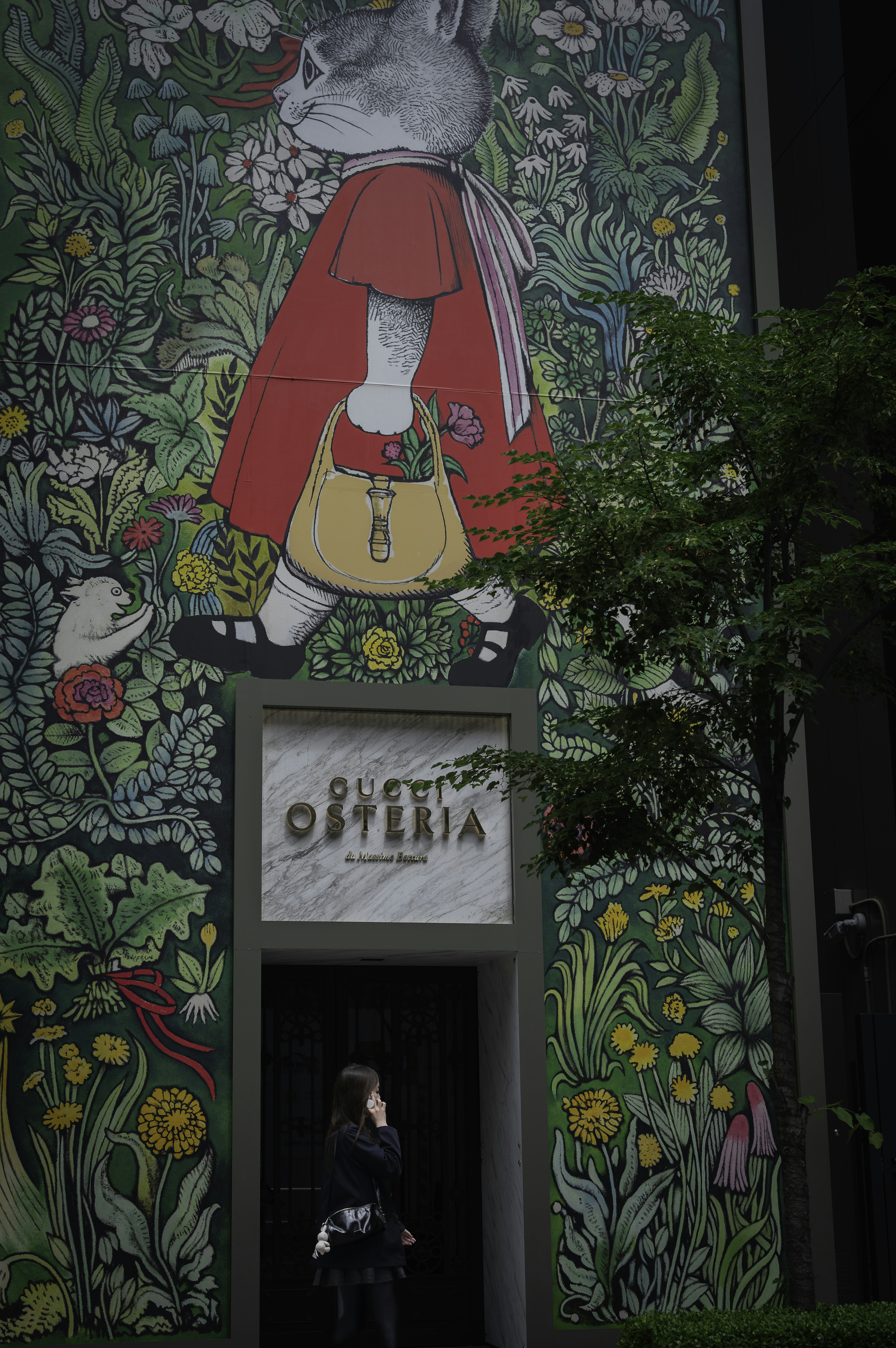 Girls in the Garden: A Feline Mural and Quiet Encounter at the Entrance