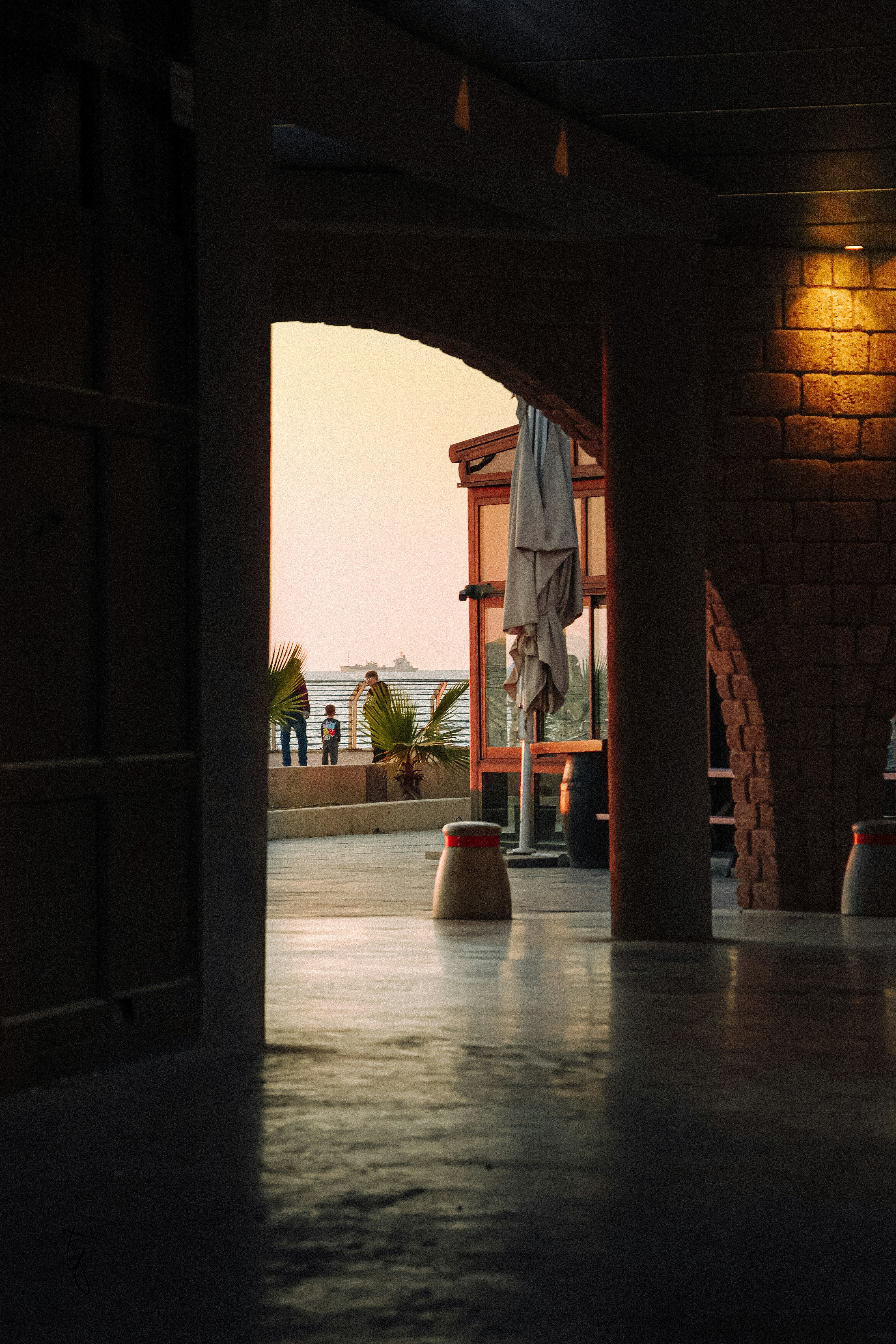 Sunlit Terrace Through a Stone Arch
