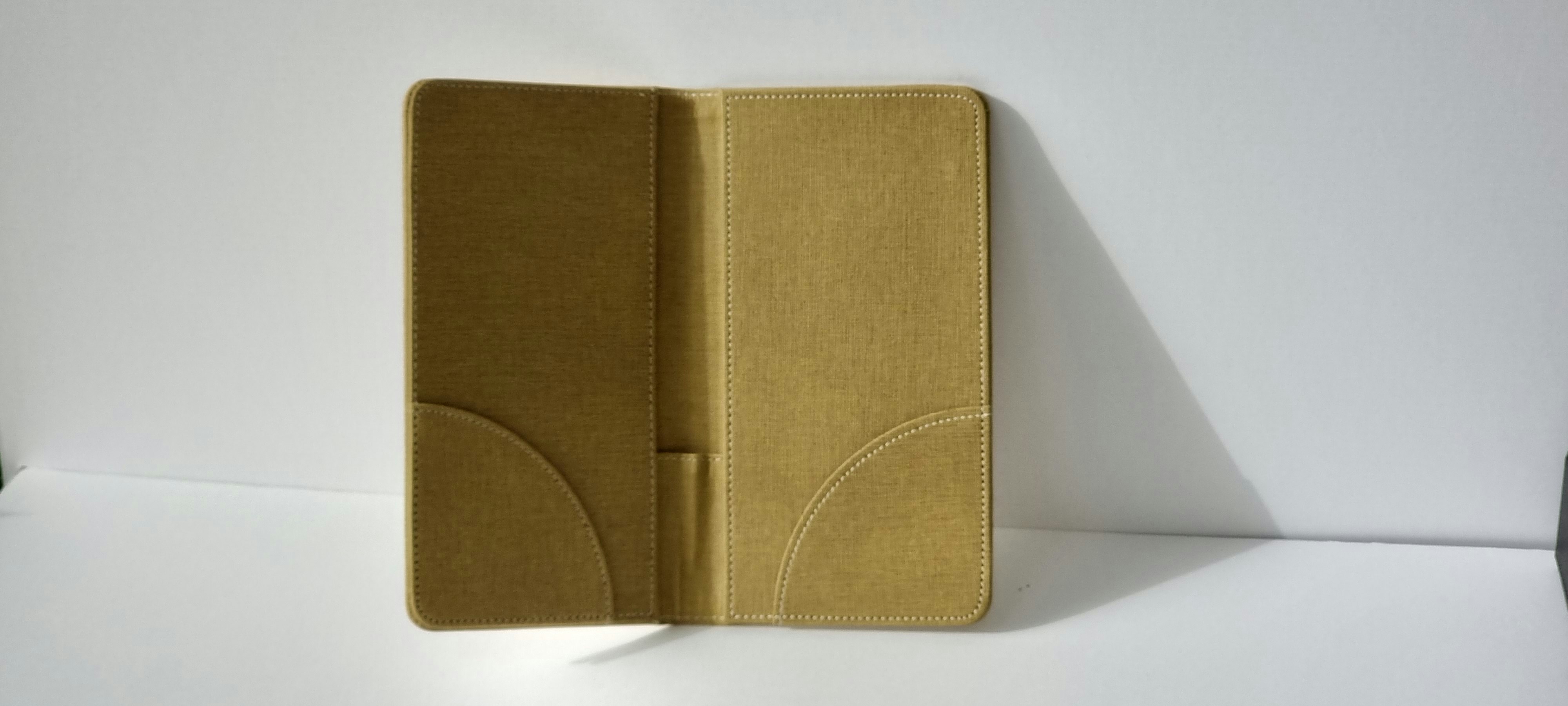An open tan folder standing on a white background.