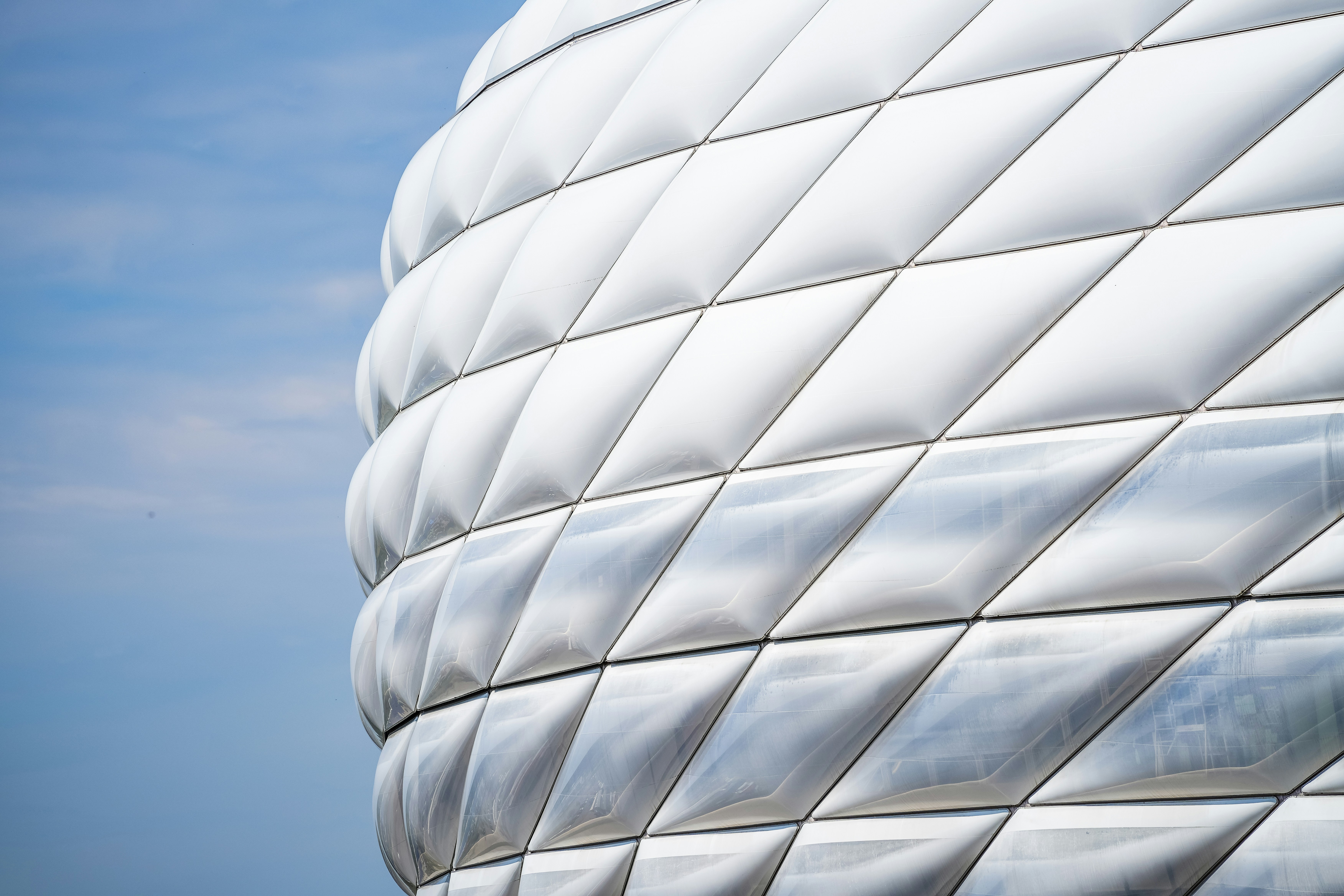 Diamond Facets: Curved Metal Panels in Sunlit Strata