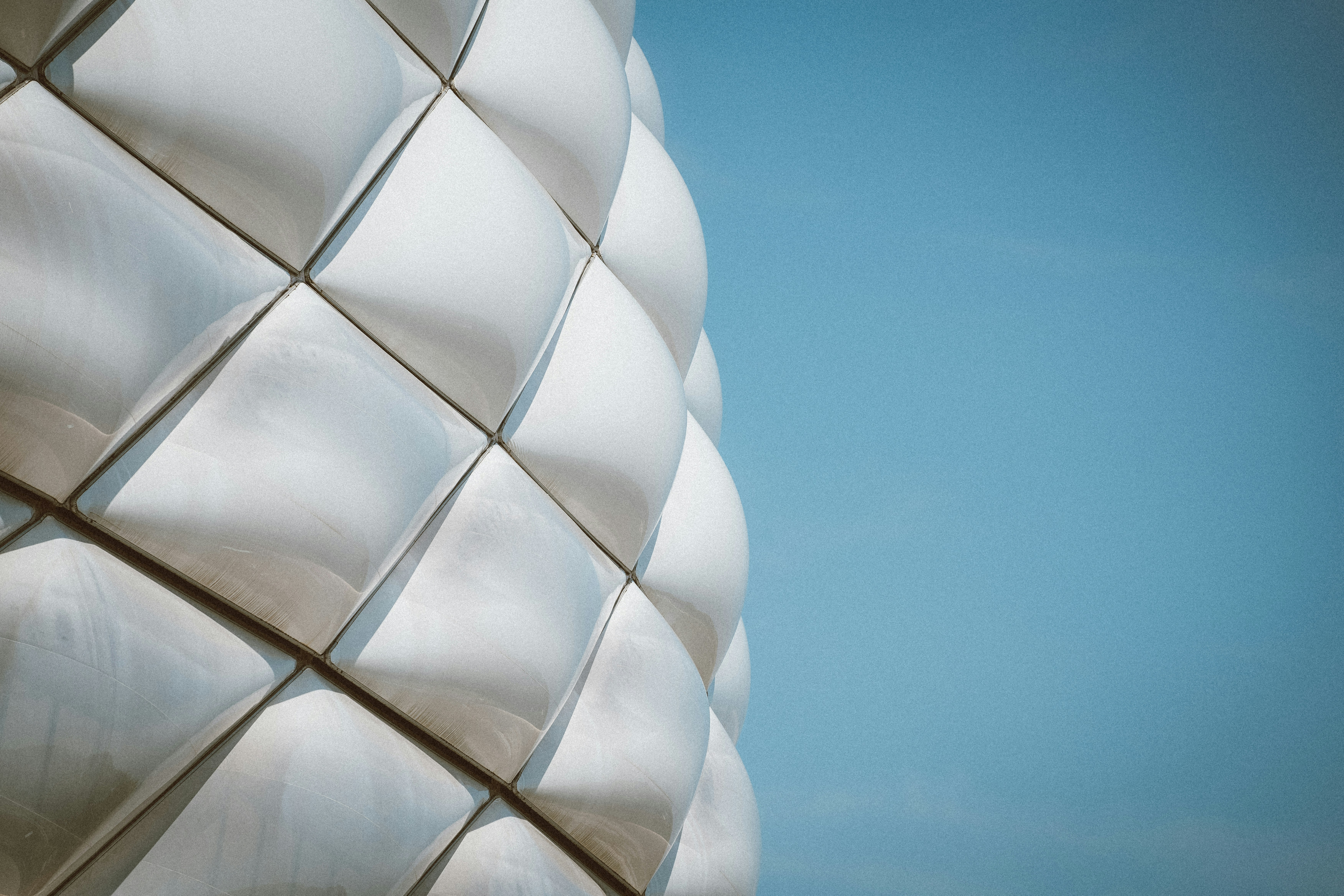 Geometric Quilt: Tessellated Domes Against a Clear Sky