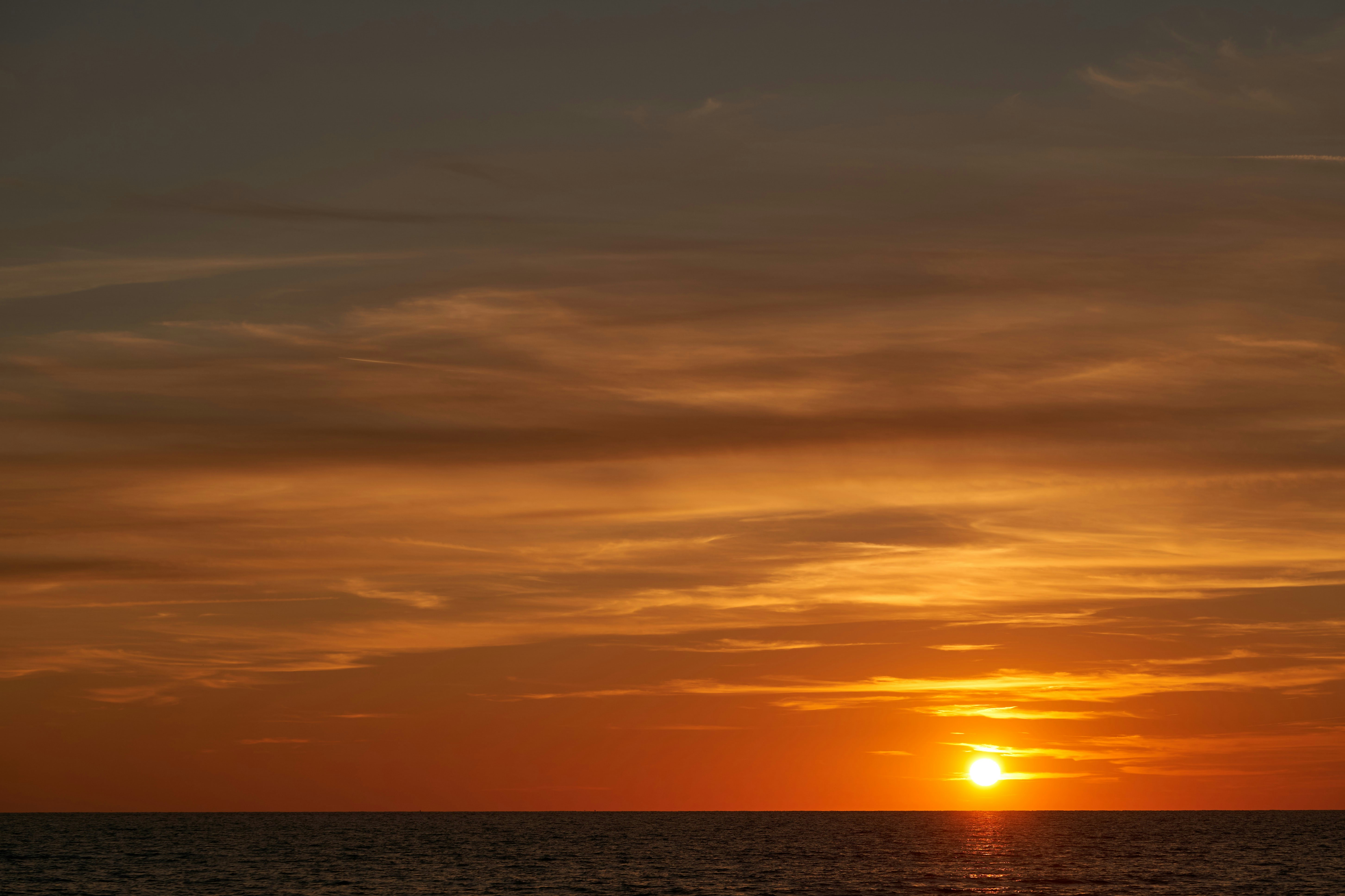 Sunlit Horizon: A Quiet Sea at Dusk