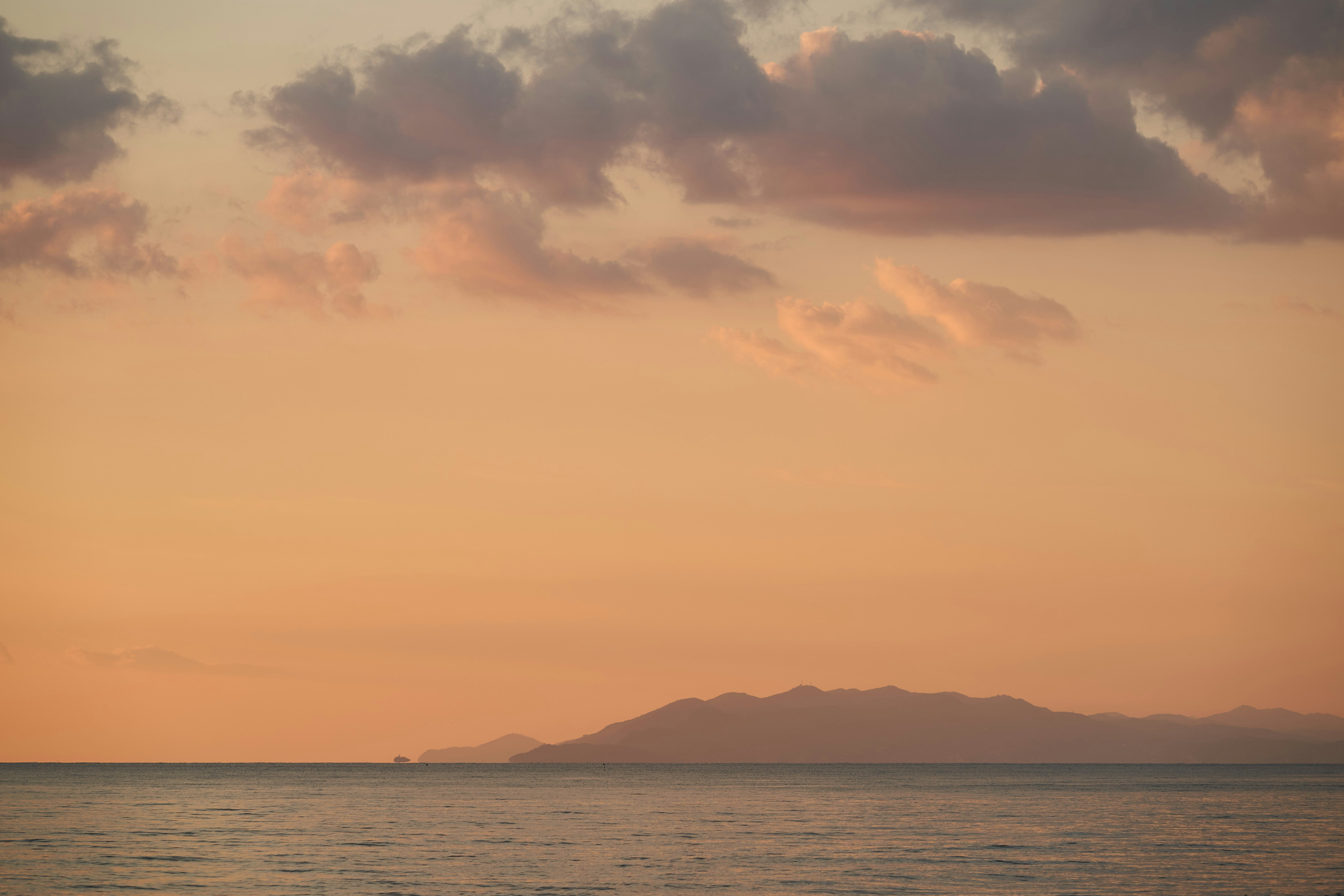 Horizon Quilt: Quiet Sea at Sunset Over Distant Peaks
