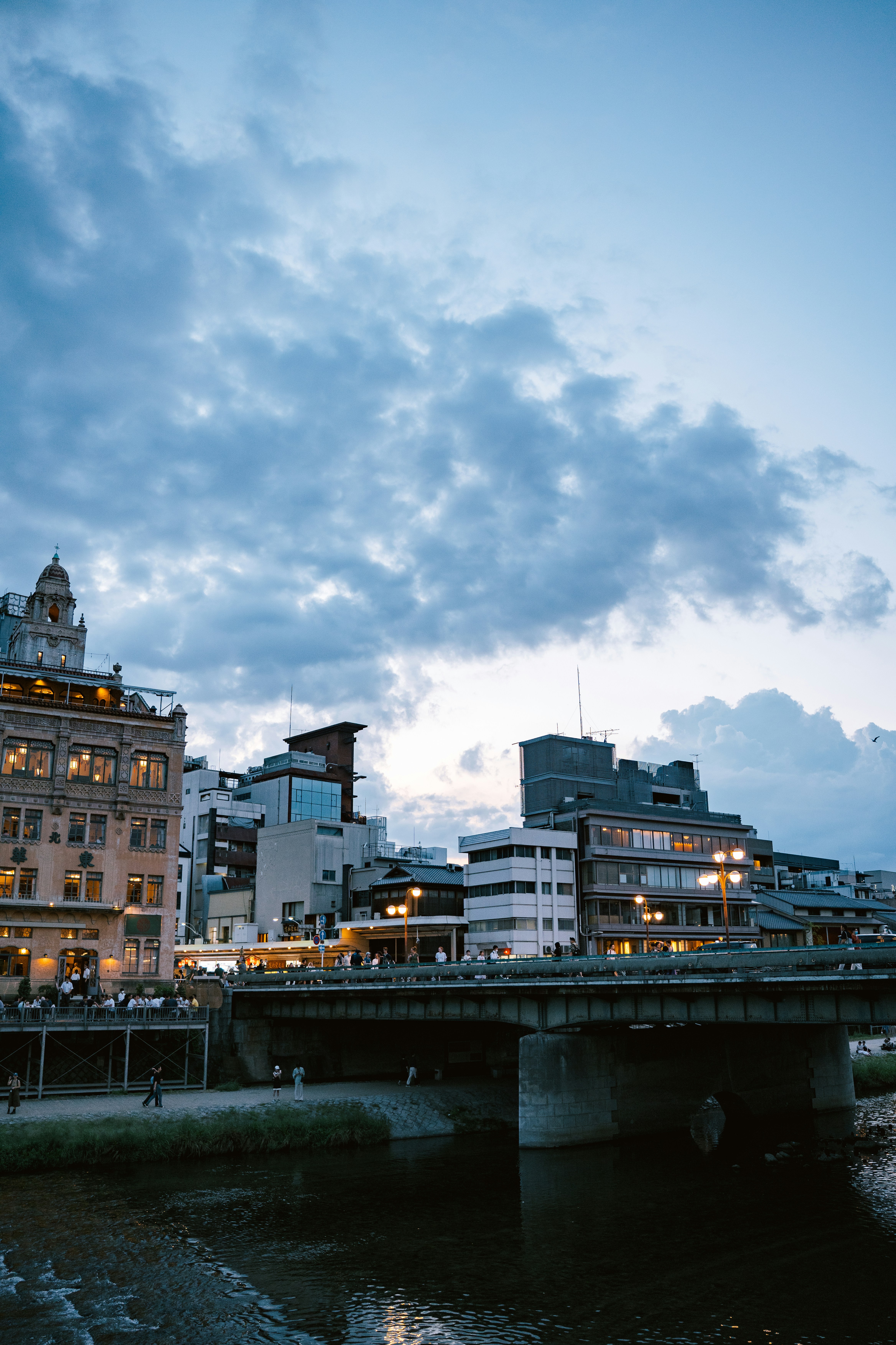 City by the River at Dusk: A Weaving of Buildings and Cloudscape