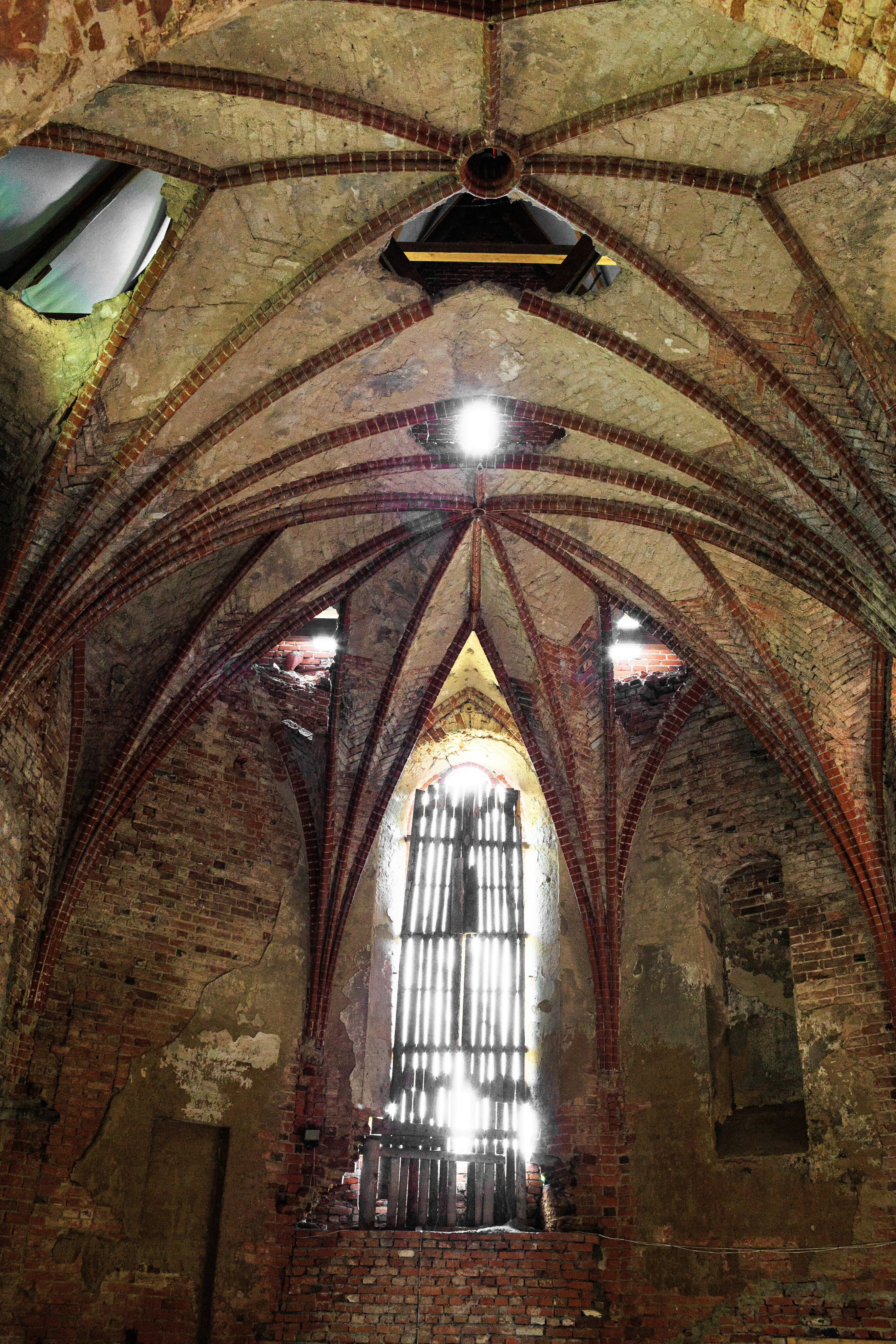 Ribbed Vaults Beneath a Stained-Glass Windowed Gloom